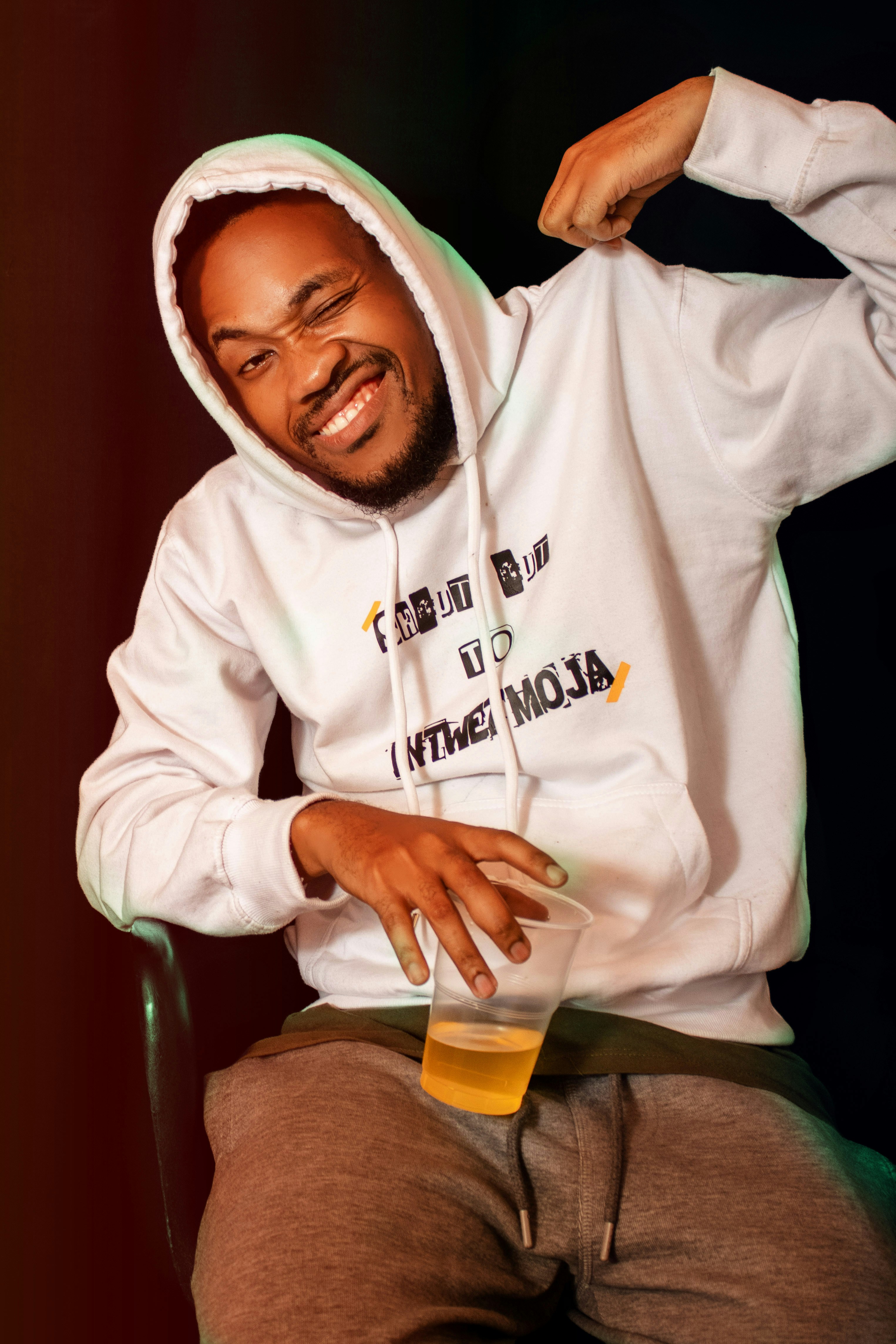 Hoodie Groove: Neon Lights and a Cheerful Pose