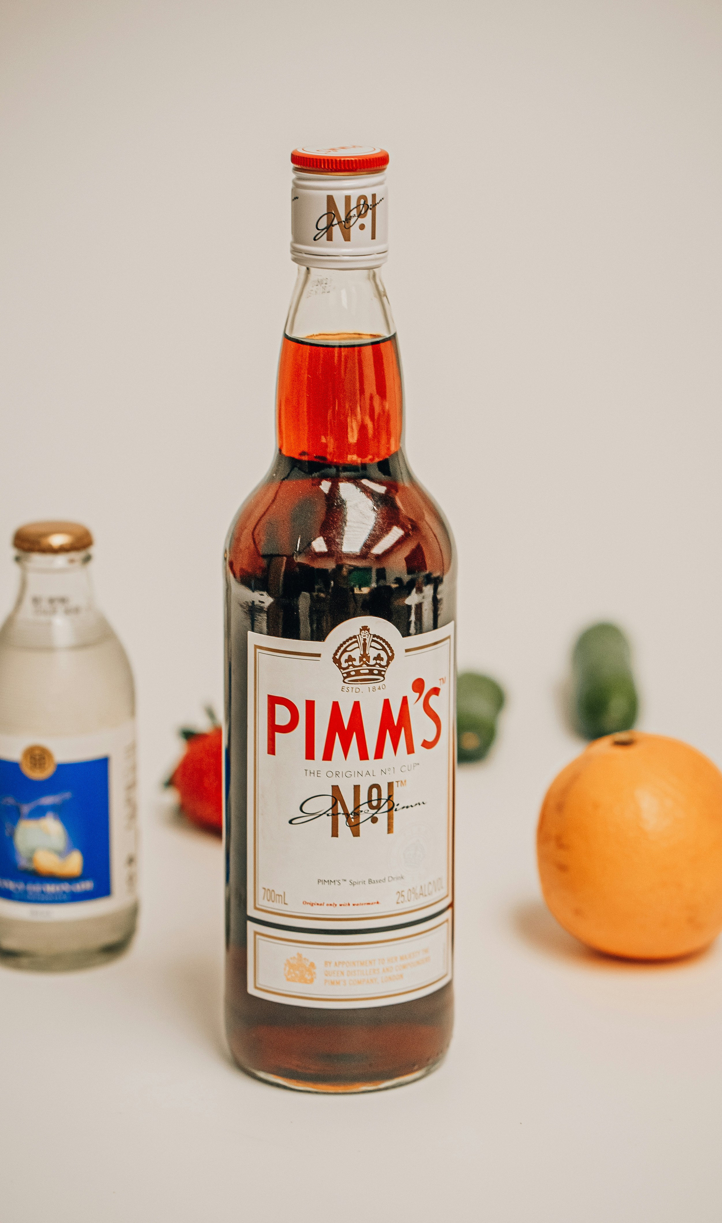 A bottle of pimm's next to an orange photo – Free Plant Image on Unsplash