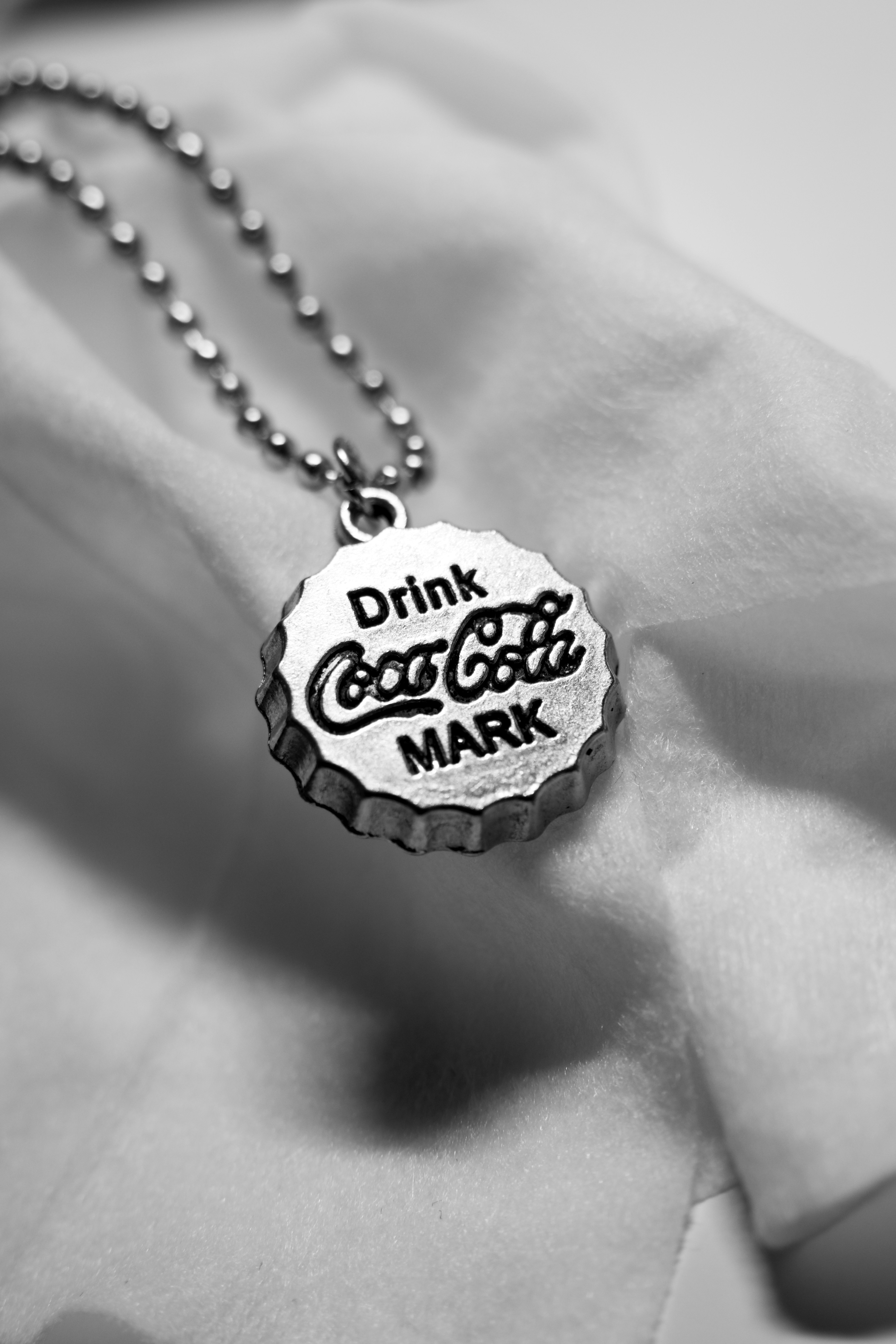 Metallic Soda Charm: A Close-Up on a Coca‑Cola Pendant