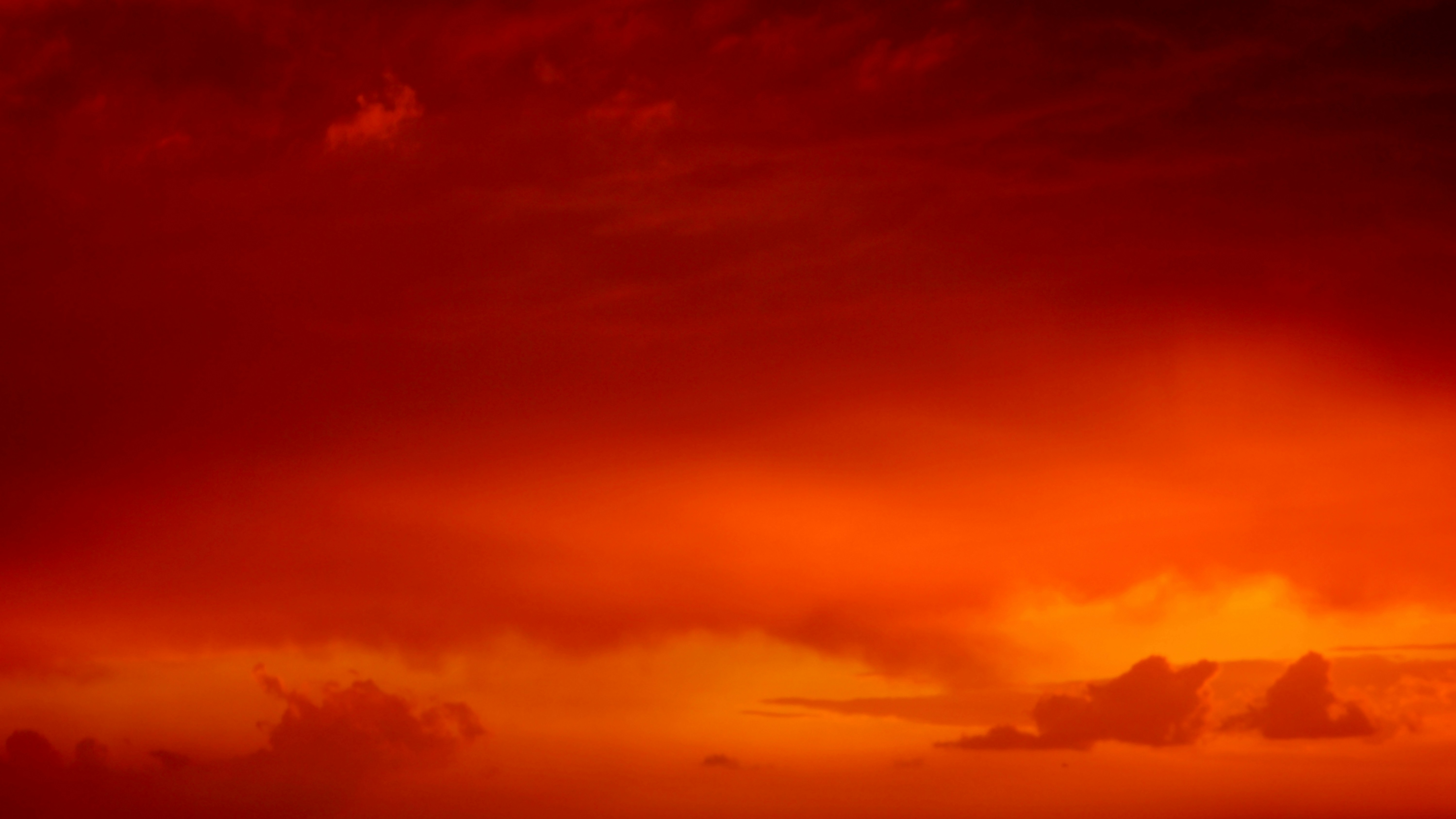 A red sky with a plane flying in the distance photo – Free Red Image on Unsplash