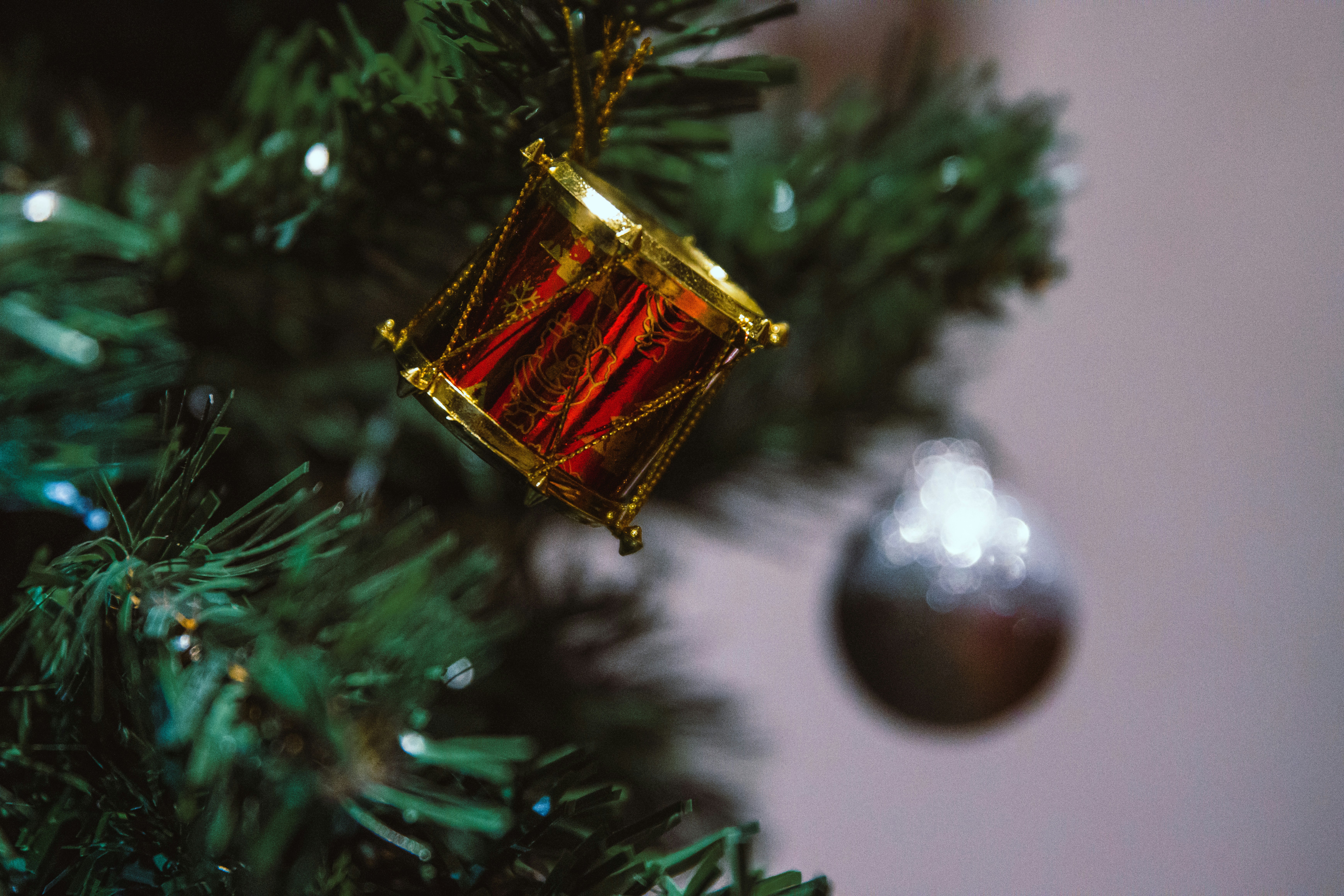 A Tiny Golden Lantern Adorns a Velvet-green Christmas Tree