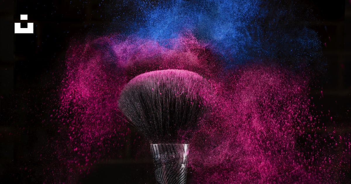 A Purple And Blue Powdered Makeup Brush On A Black Background Photo