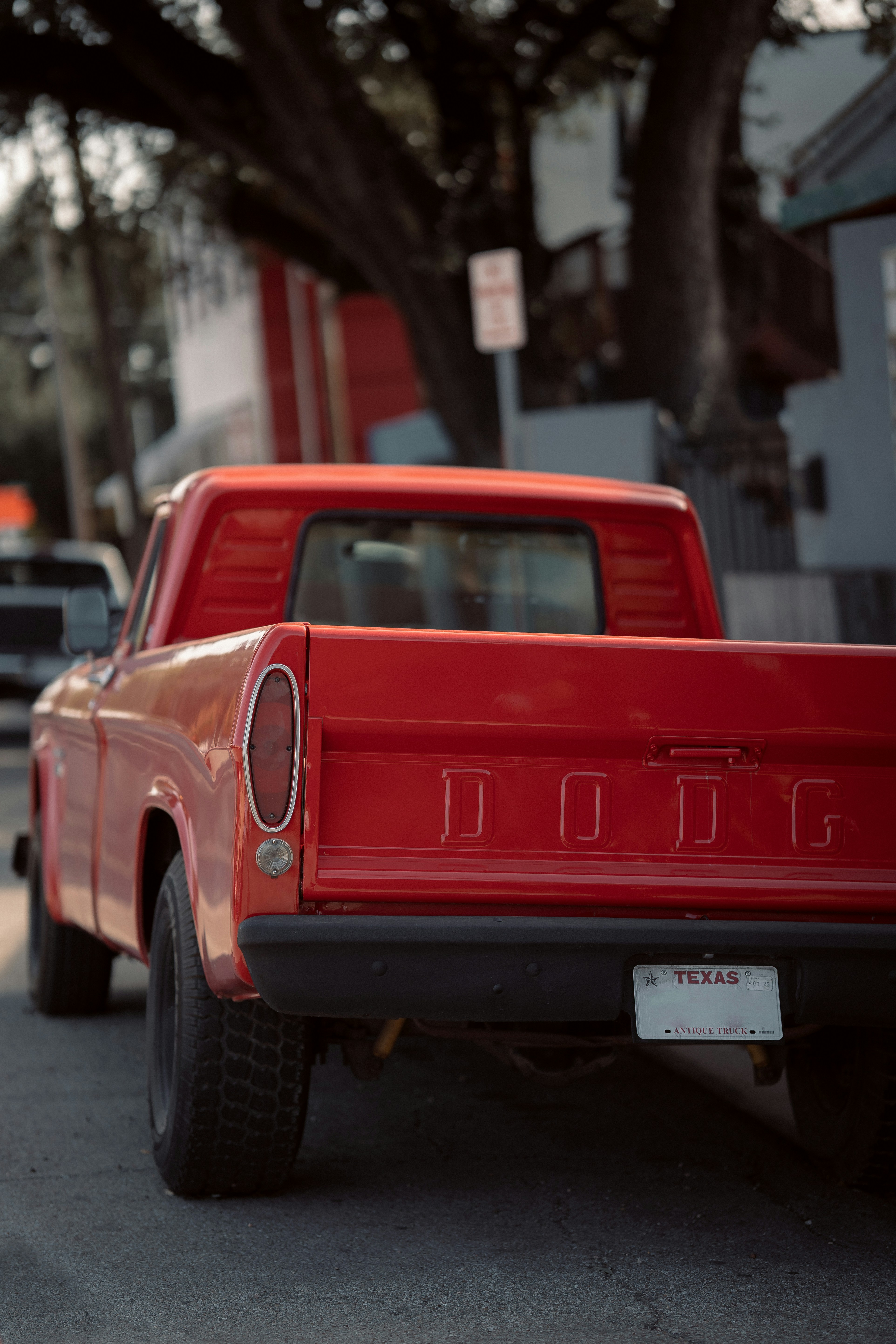 Rear-View Red: A Vintage Pickup Anchored in a Quiet City Street