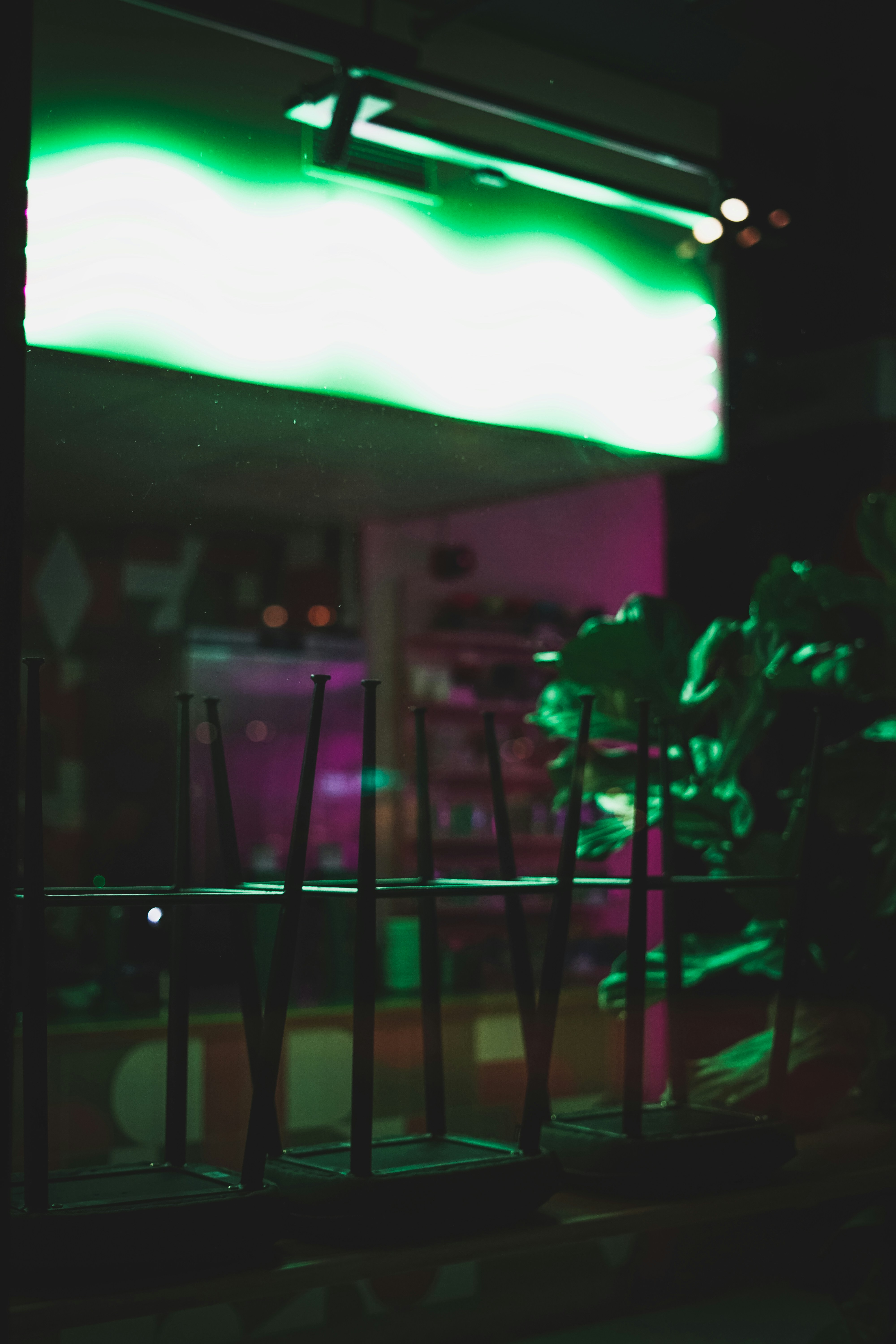 A restaurant with a neon green sign above it photo – Free Oslo Image on ...