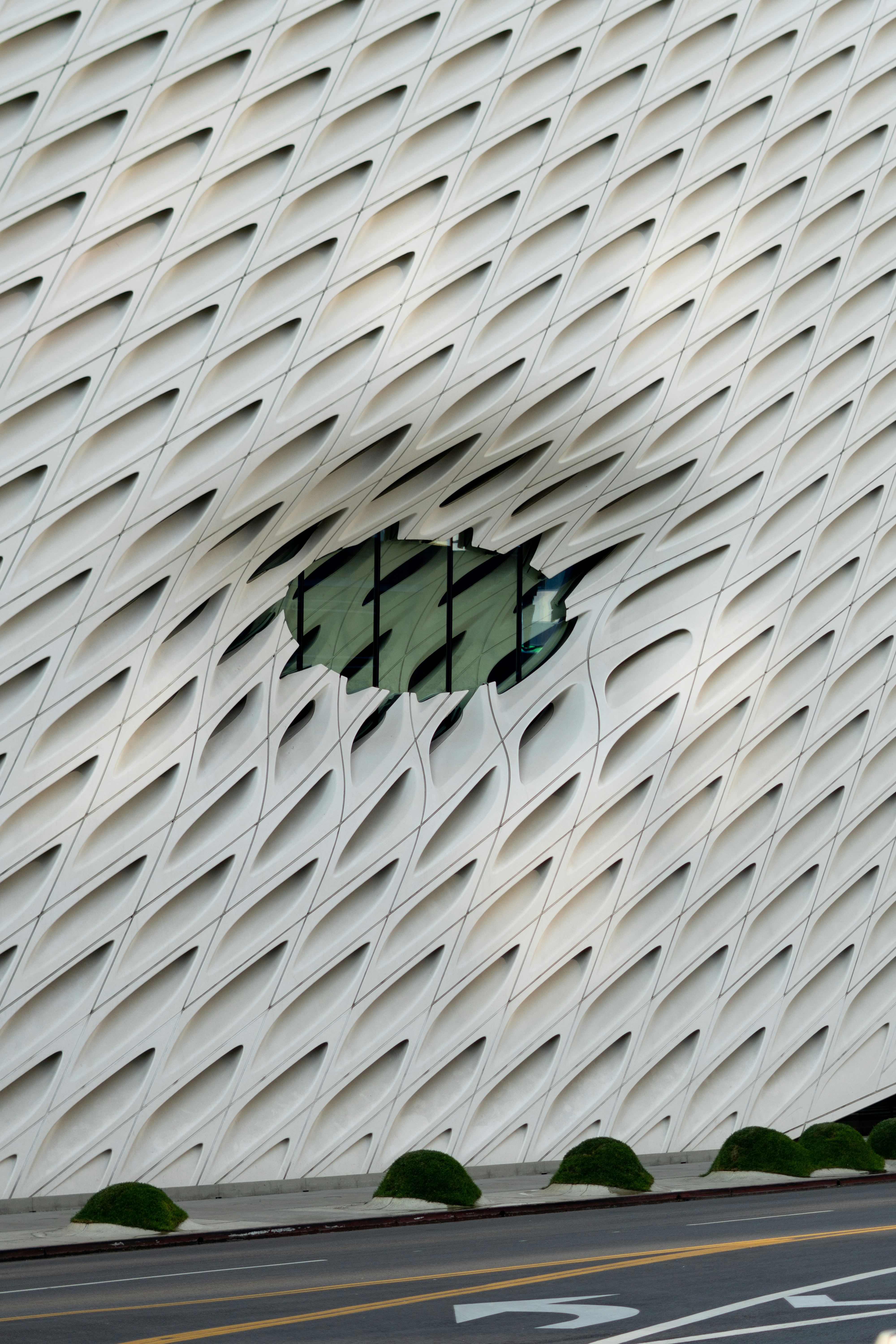 A white building with a hole in the side of it photo – Free Grey Image ...