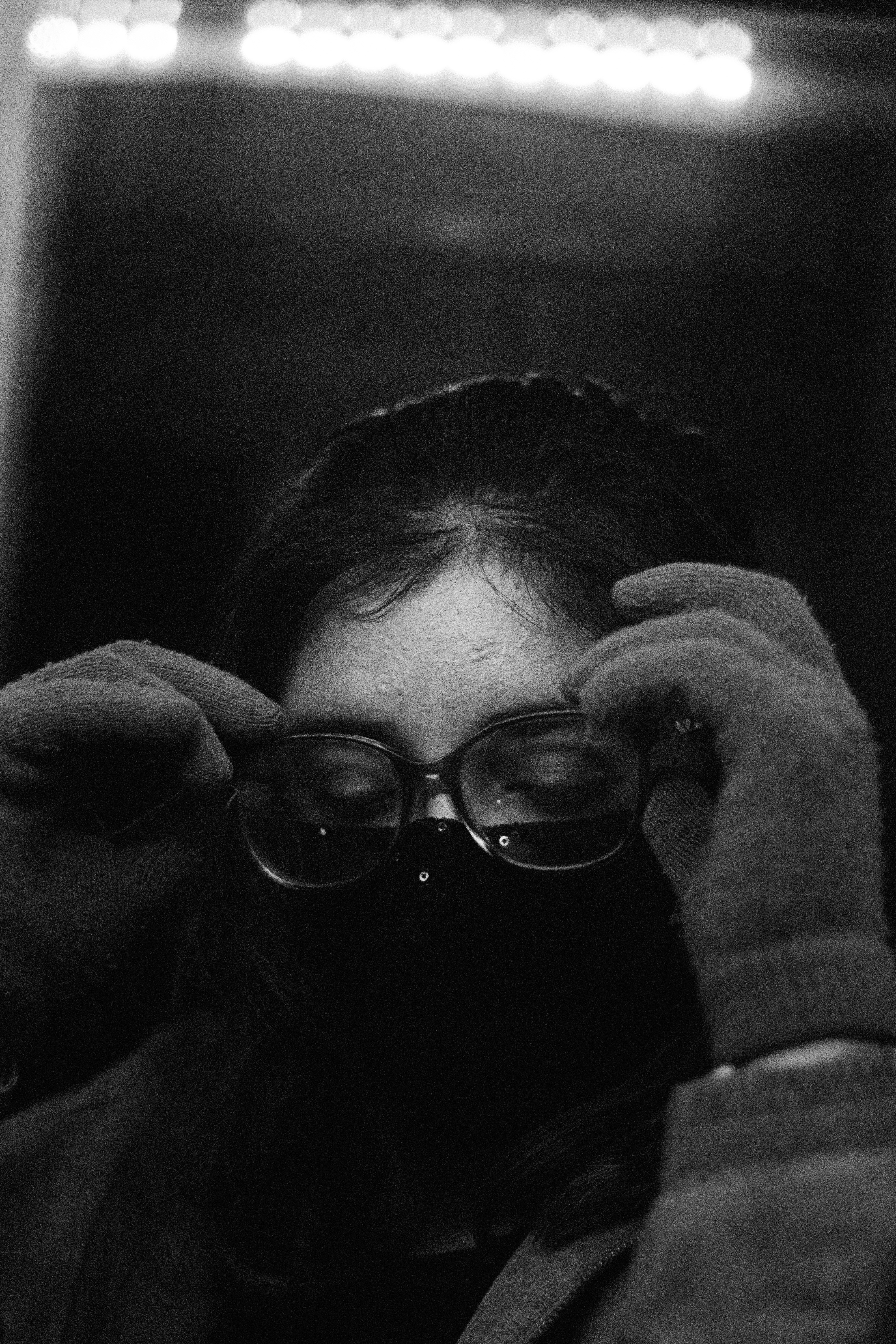 a black and white photo of a person wearing glasses