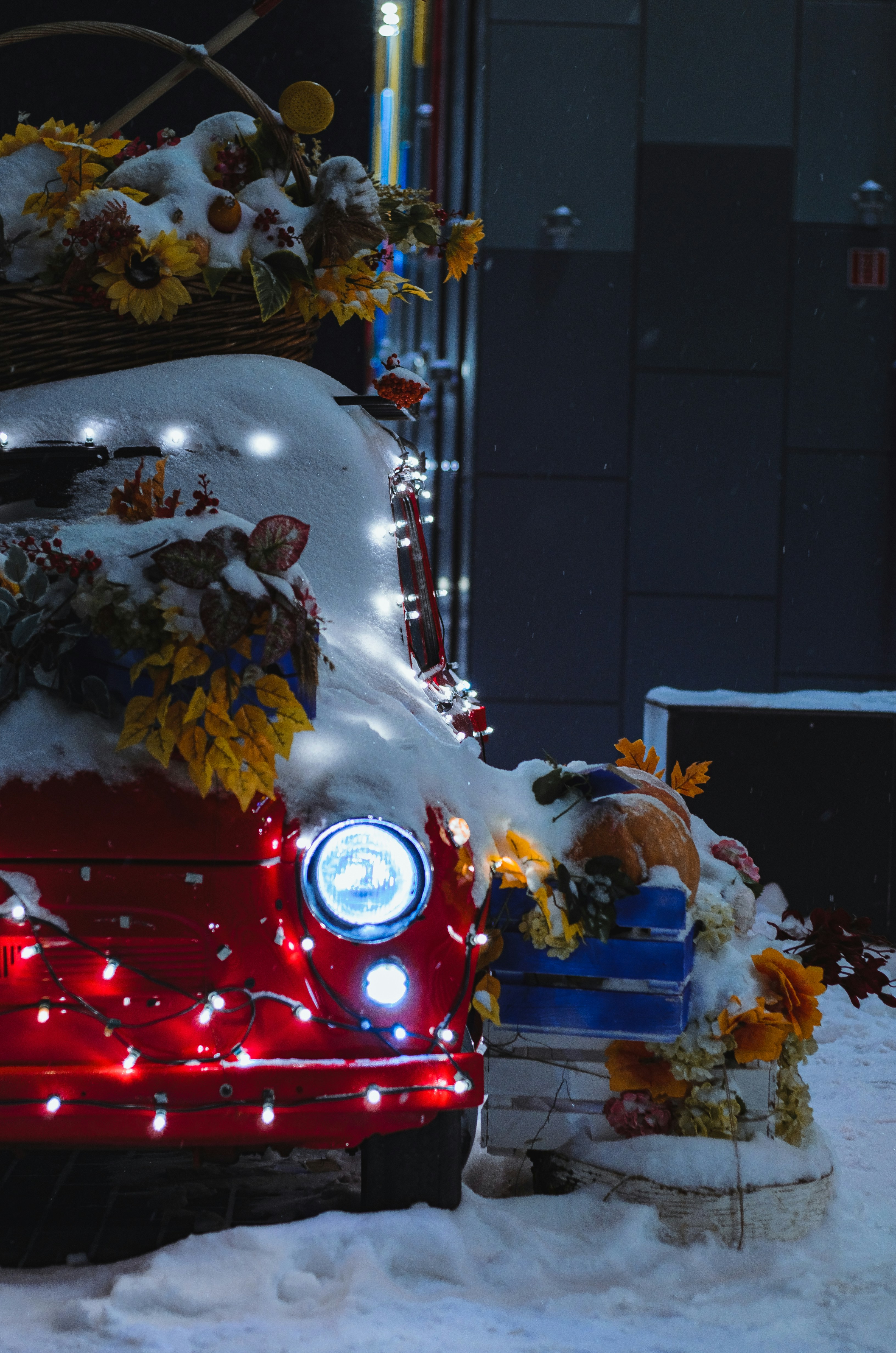 A red car covered in snow with christmas lights photo – Free Light ...