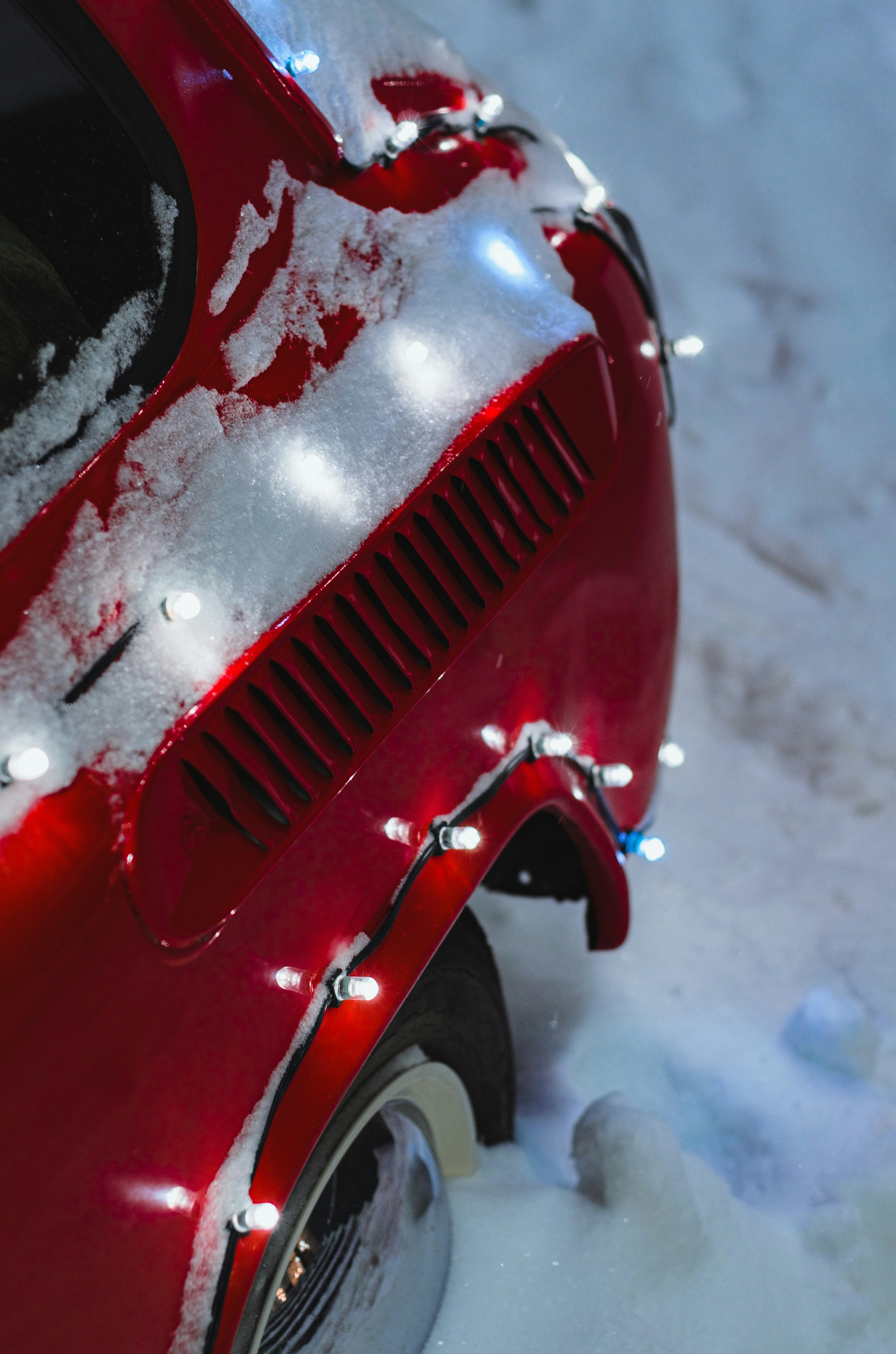 Snow-Kissed Crimson Classic: close-up of a festive red vintage car