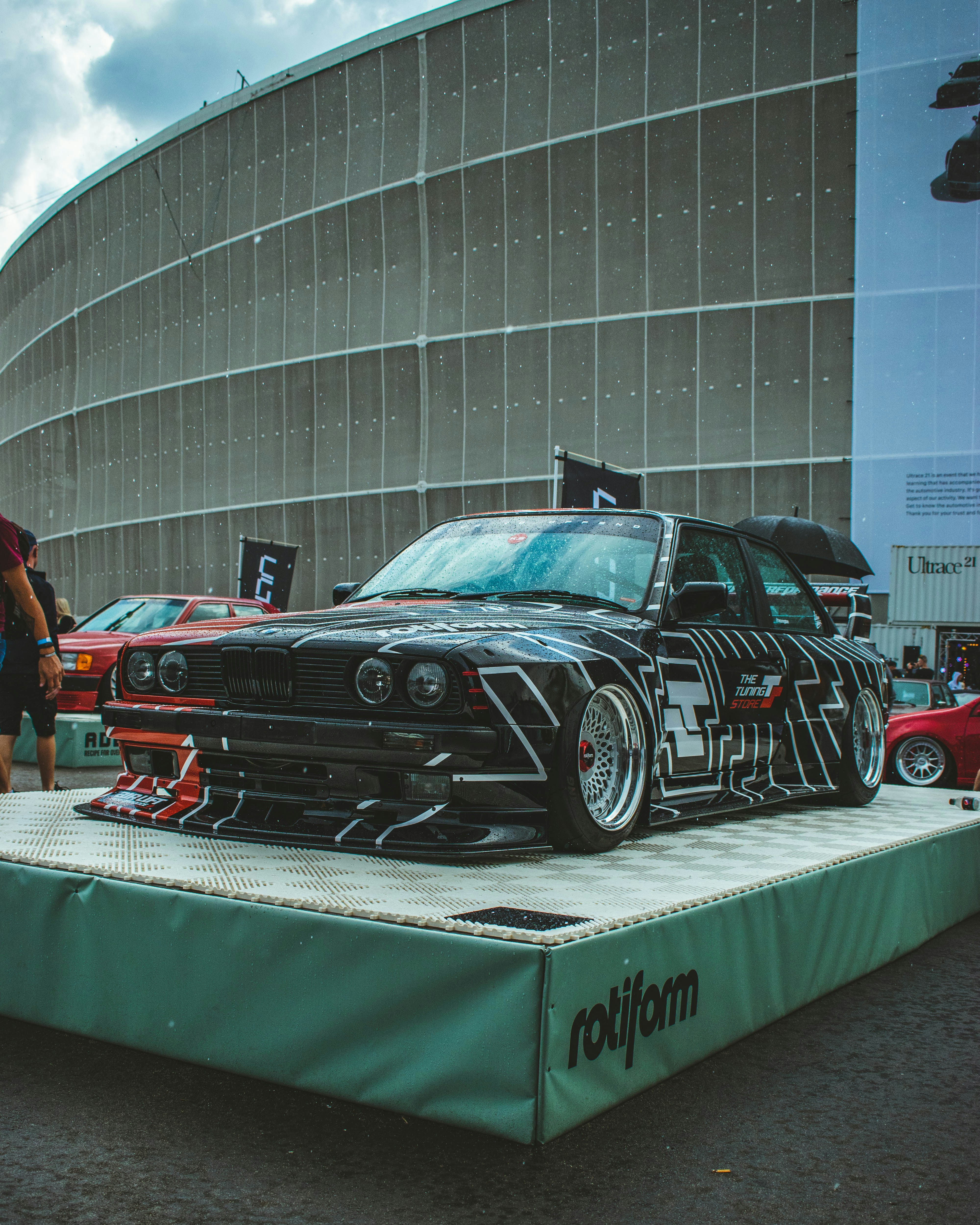 Midnight Geometry: BMW E30 on Rotiform Stage at a Car Show