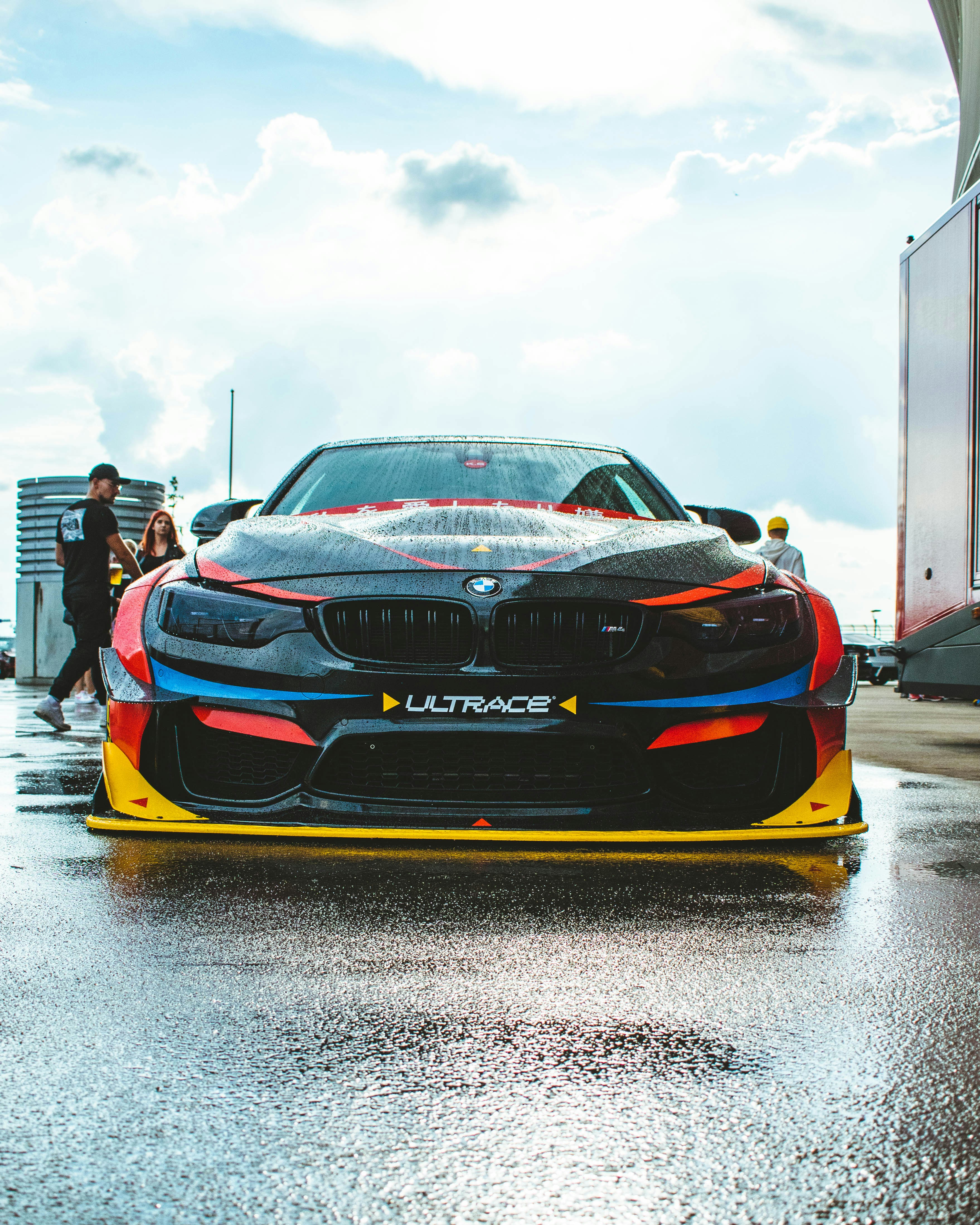 A bmw sports car parked on a wet parking lot photo – Free Vehicle Image ...