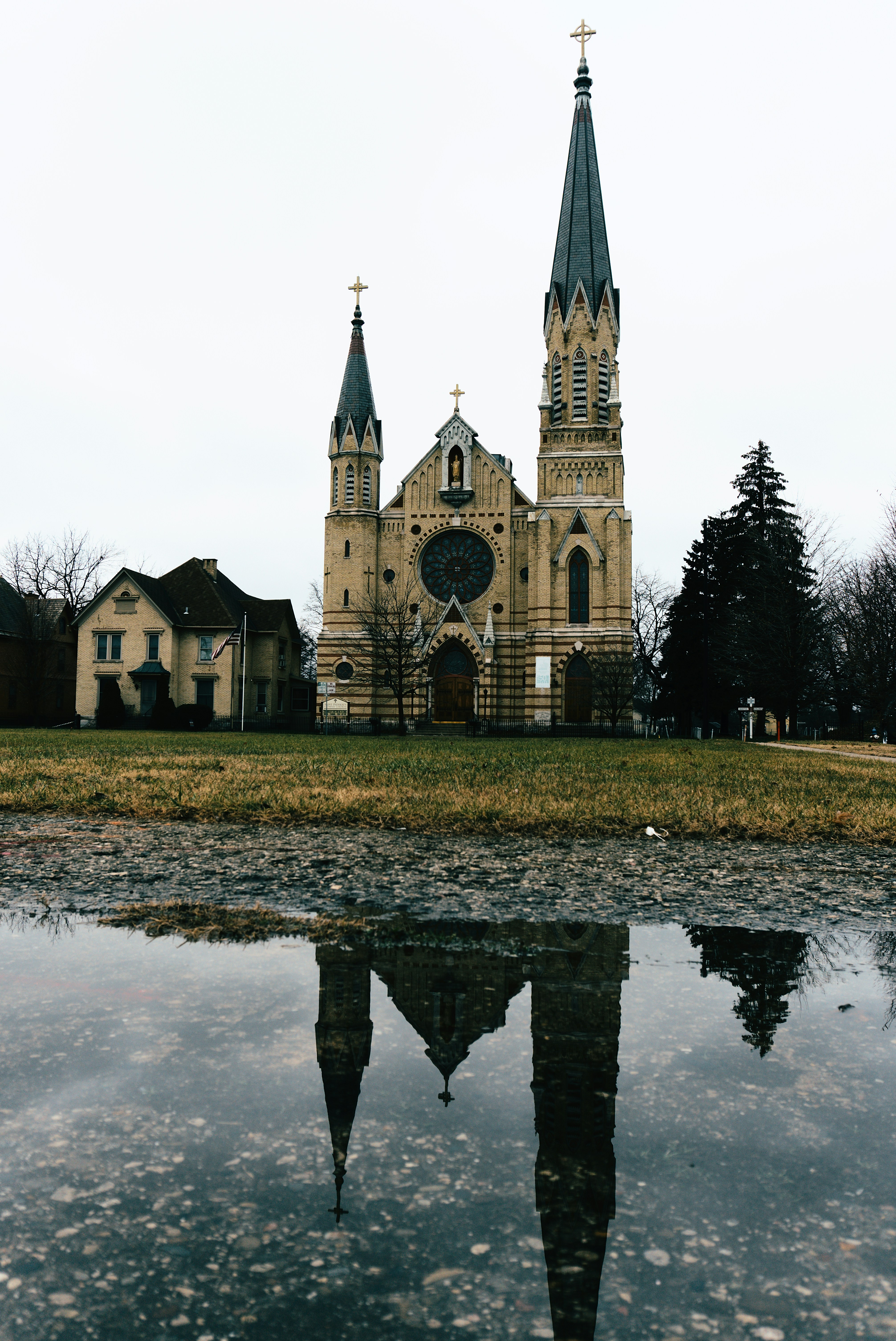 Stone Rose and Twin Spires: The Church Guarding a Quiet Reflection