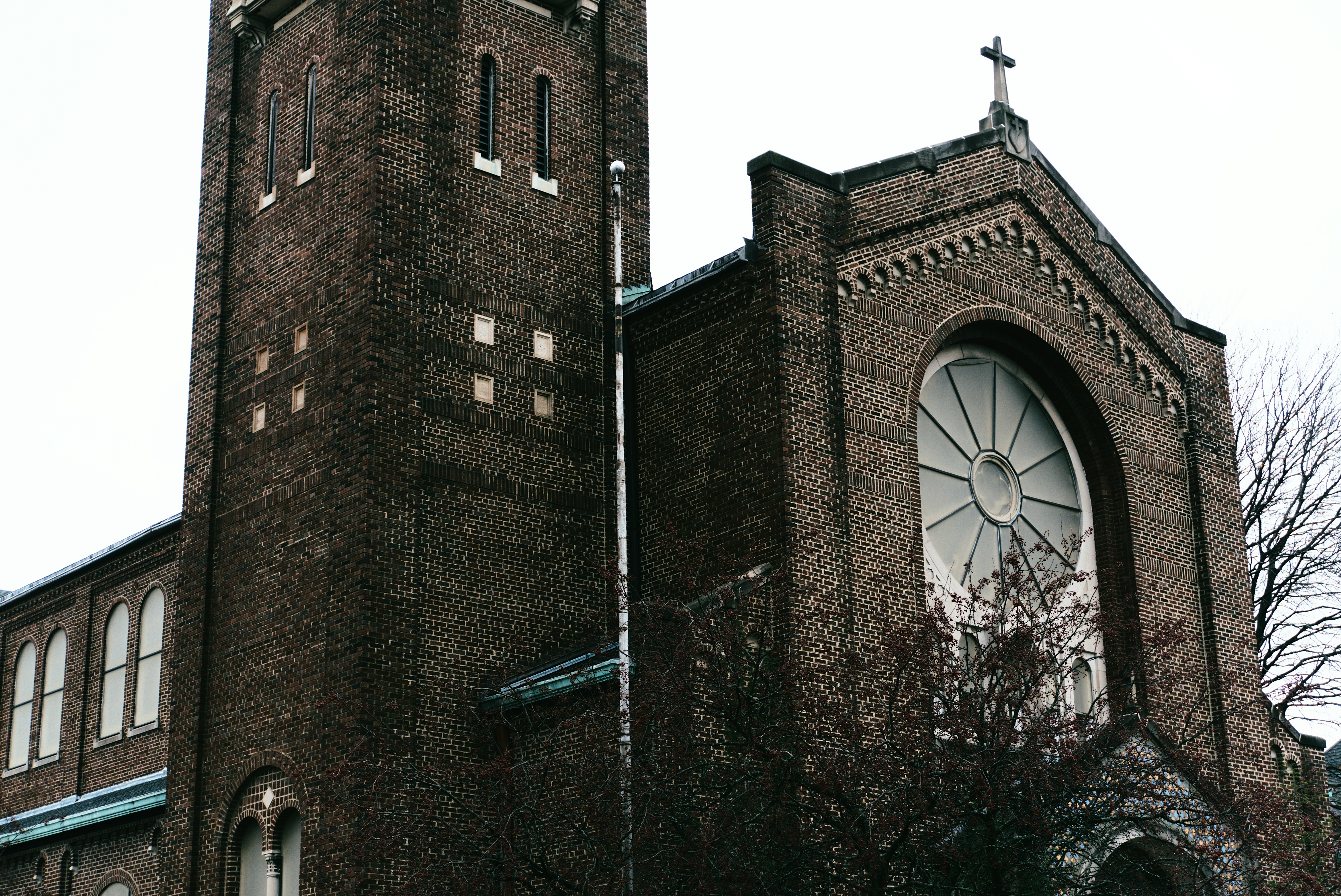 A large brick church with a clock on it's side photo – Free Building ...