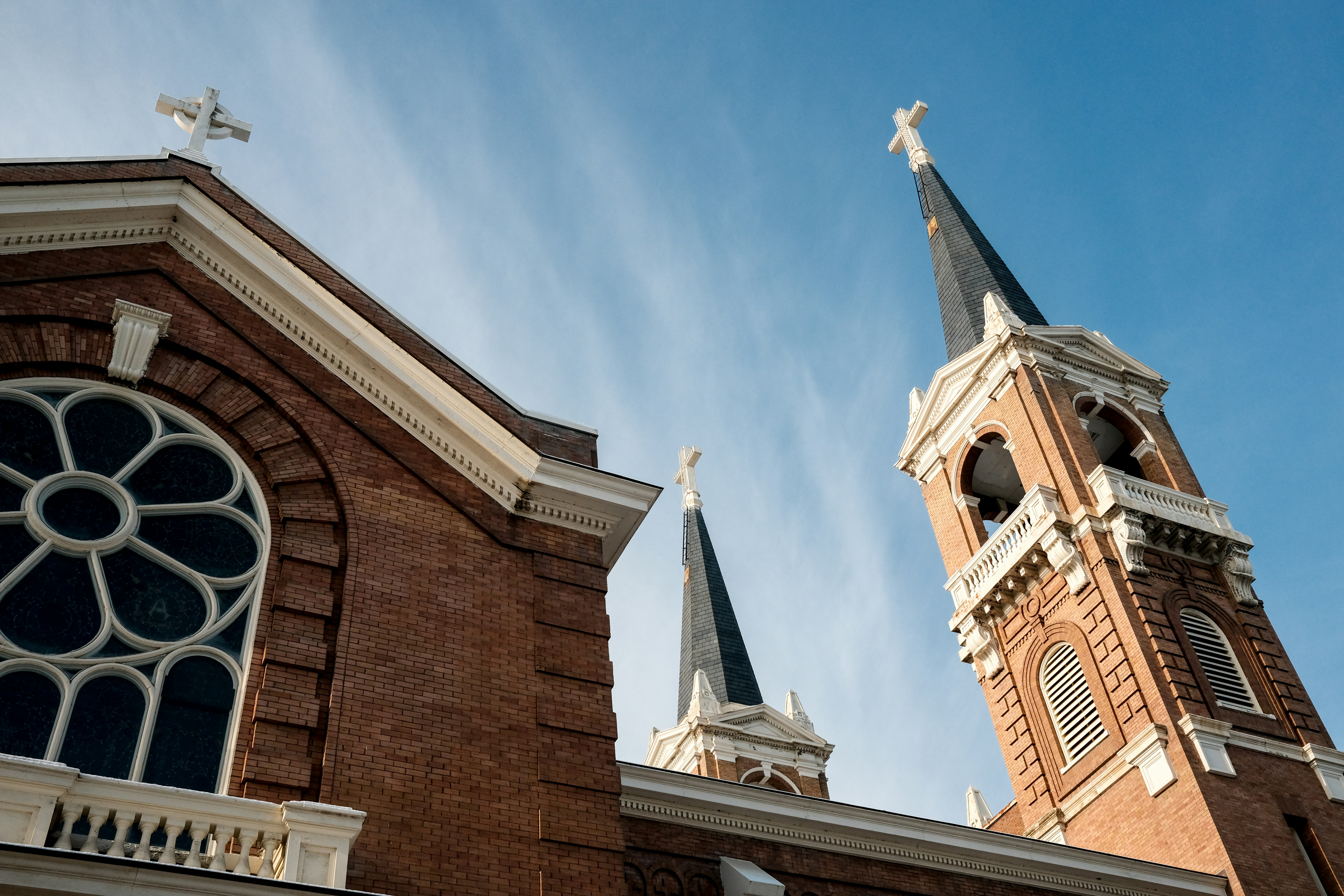a church with two steeples and a cross on top