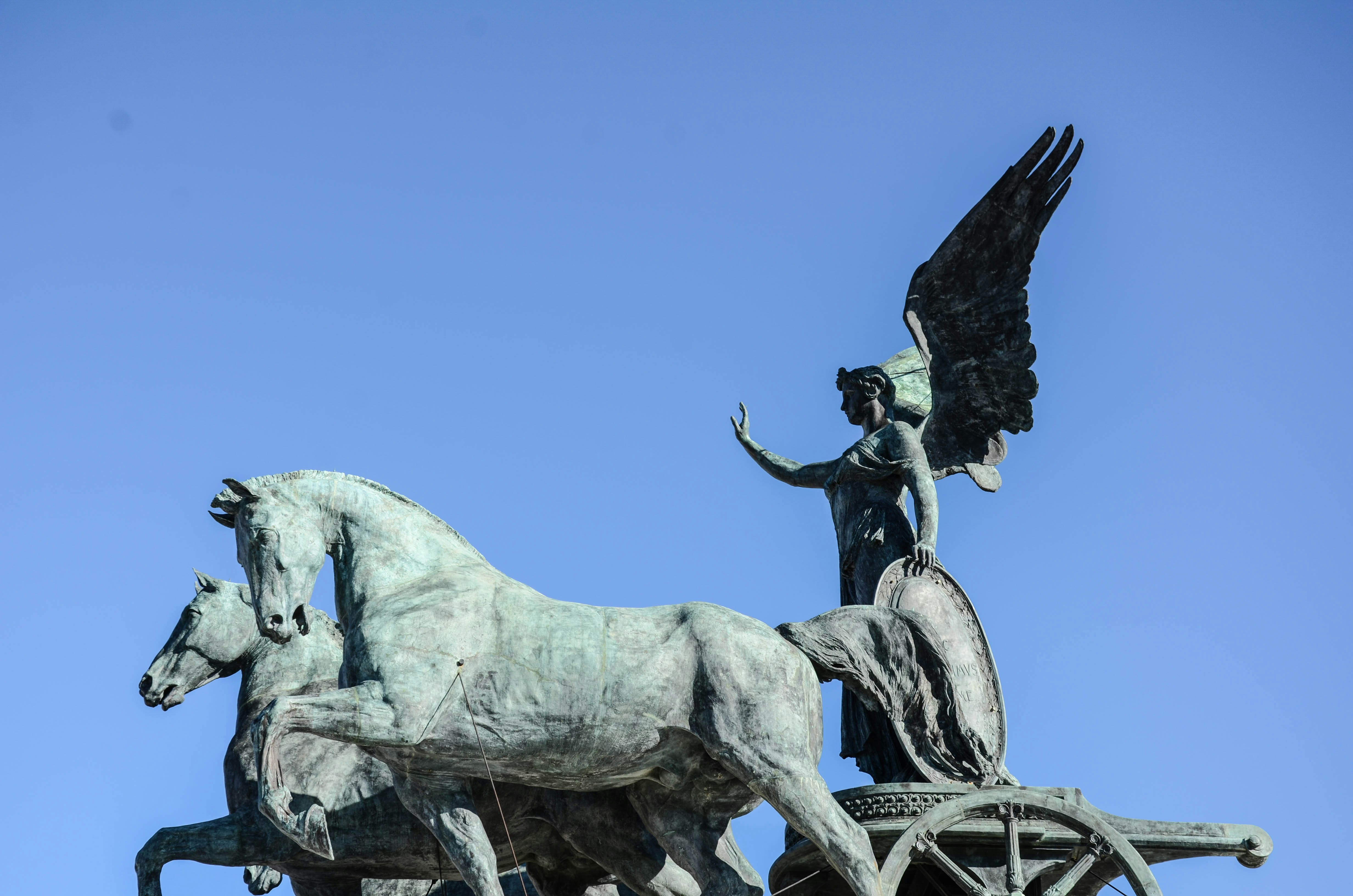A statue of an angel riding a horse and carriage photo – Free Sculpture ...