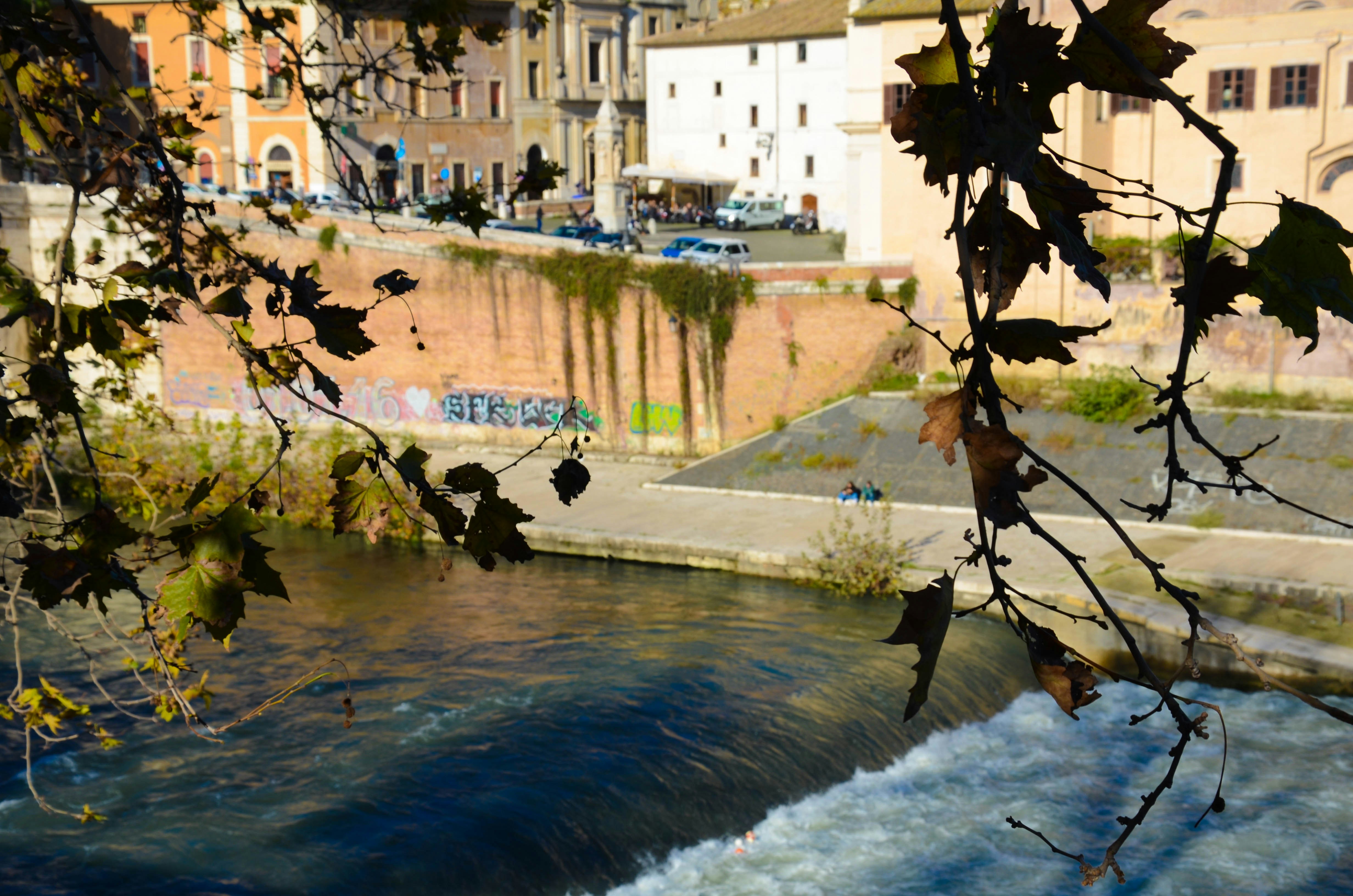 a river running through a city next to tall buildings
