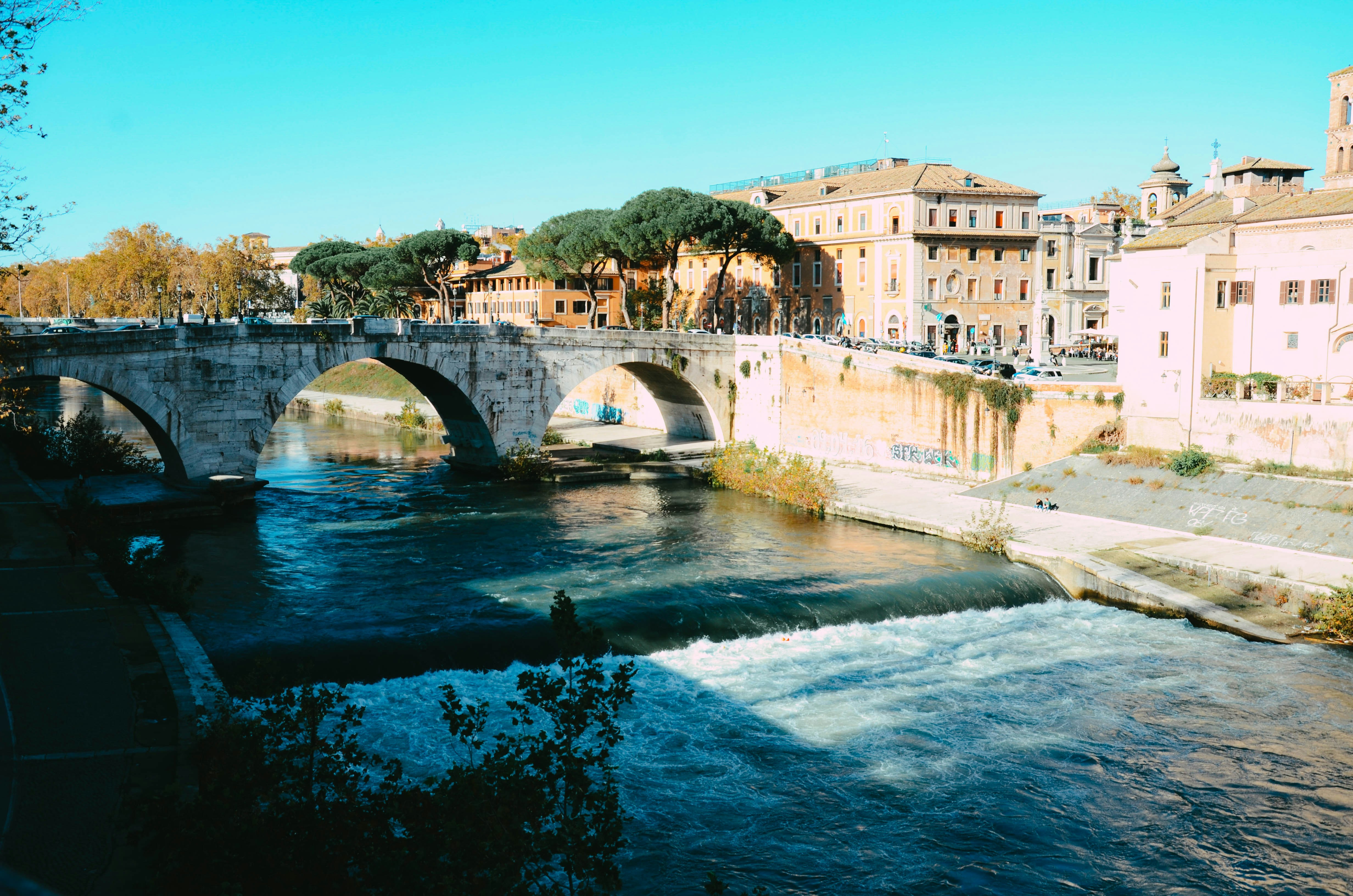 A river running through a city next to a bridge photo – Free Ancient ...