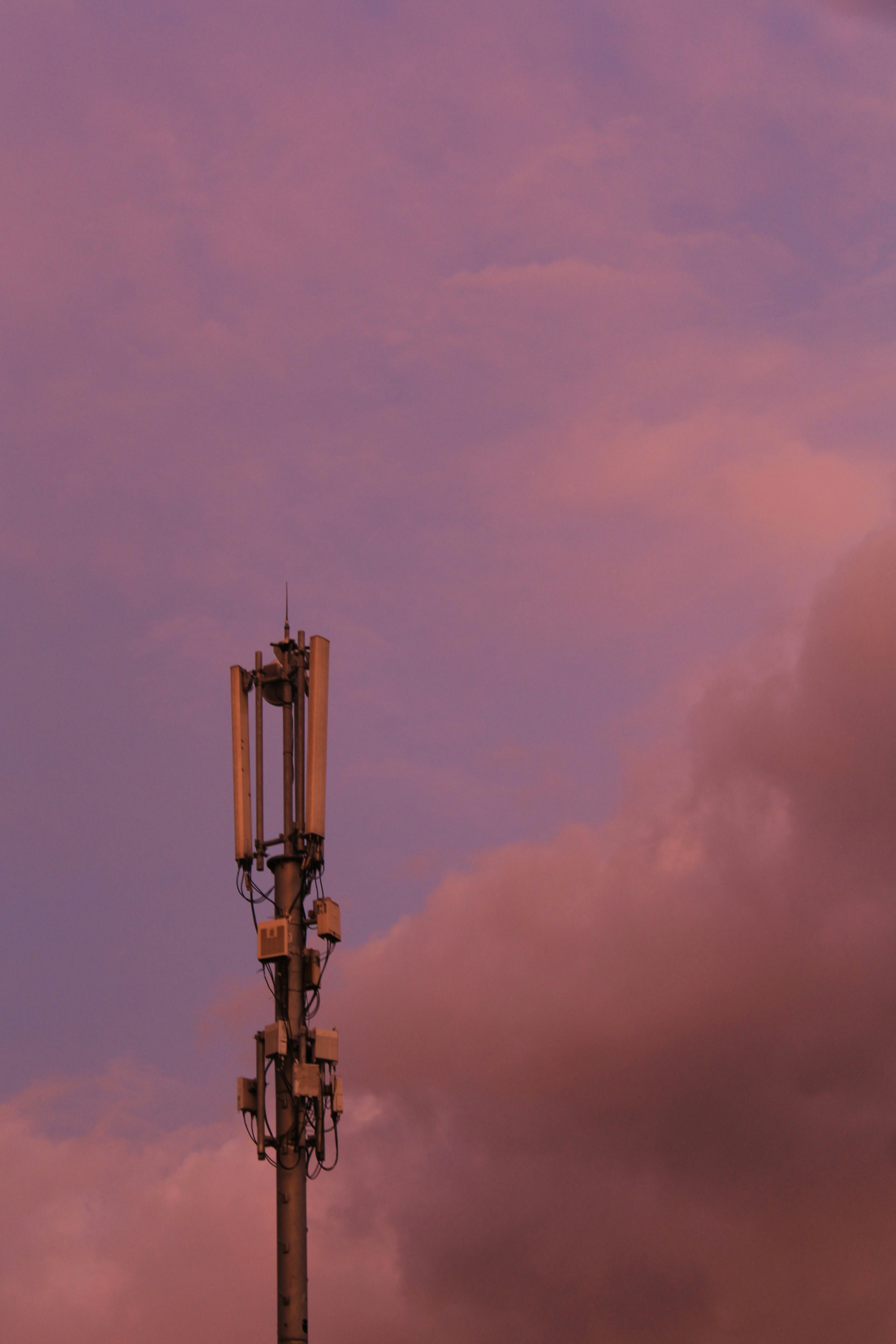 a tall tower with a cell phone on top of it