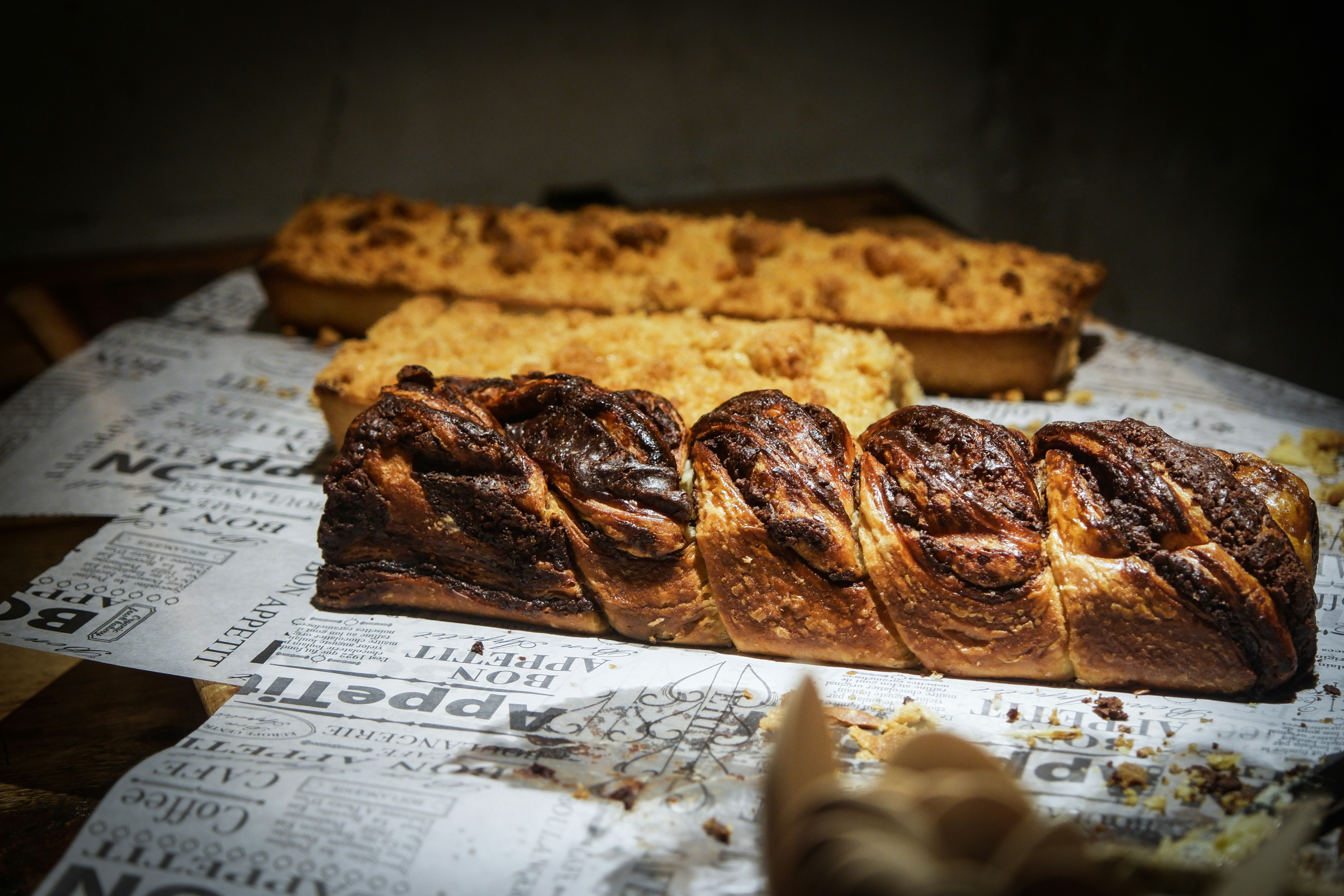 A loaf of bread sitting on top of a newspaper photo – Free Bakery Image ...