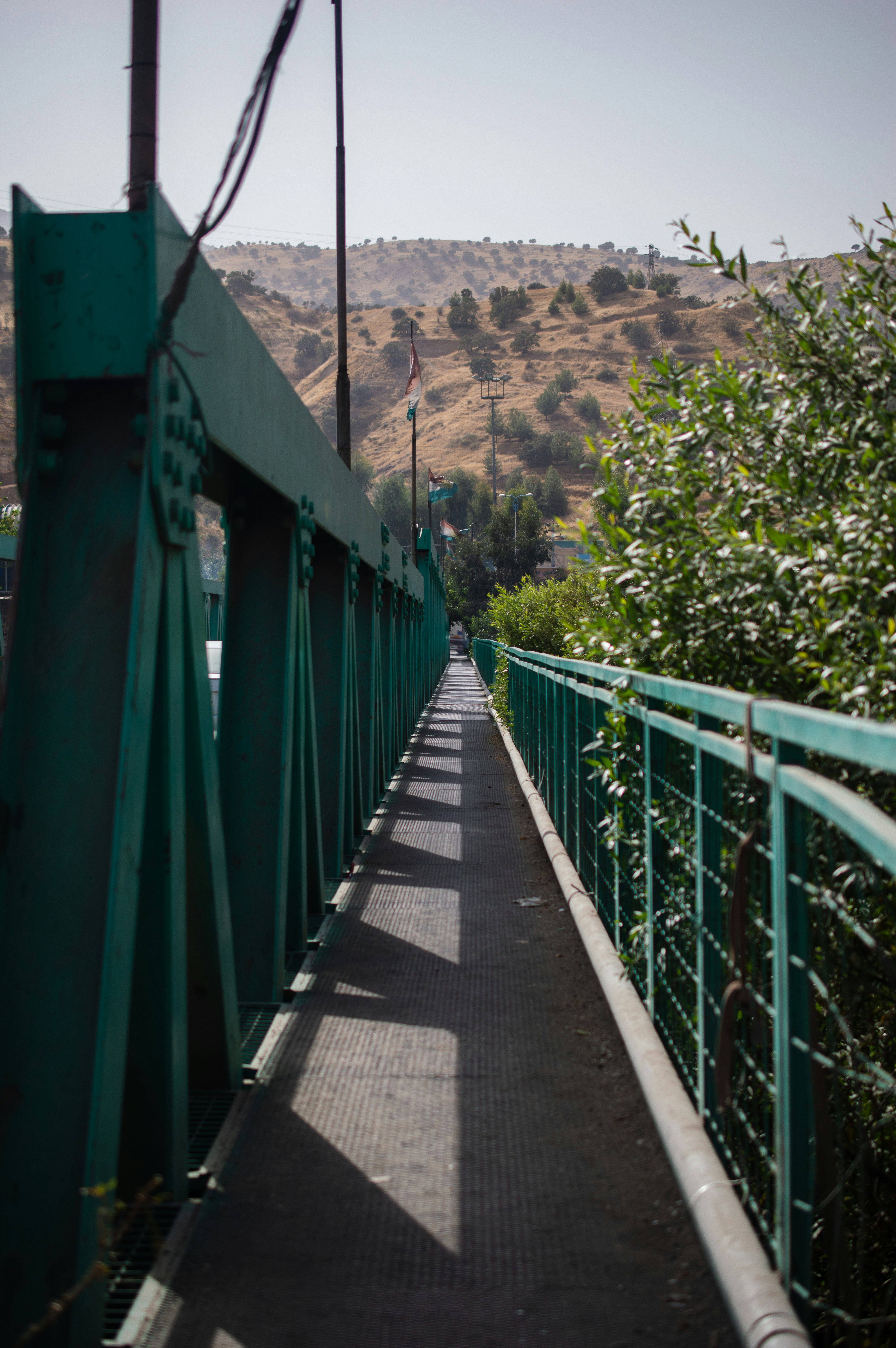 Steel Path: A Quiet Span Anchored by Distant Hills