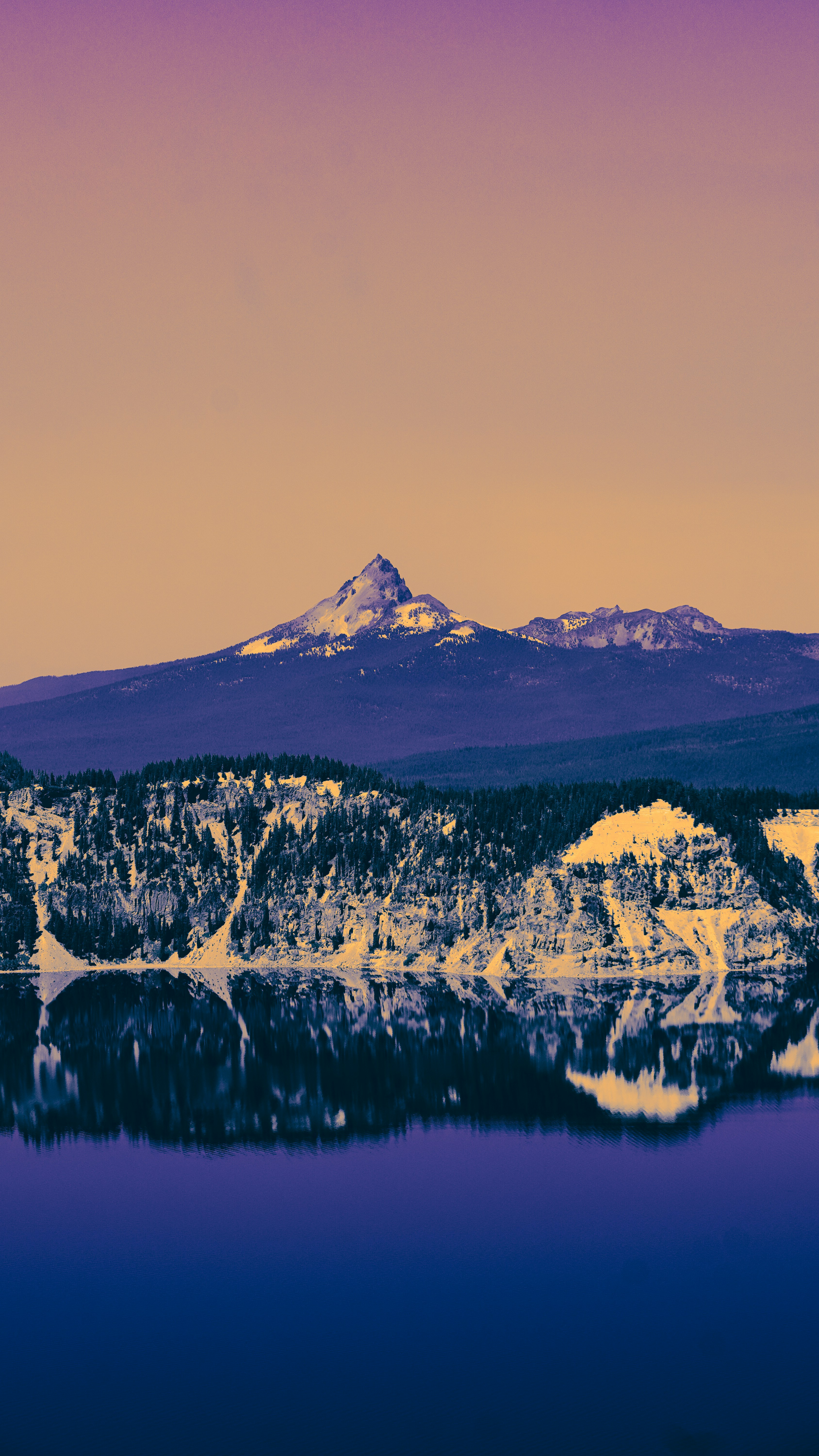 a mountain range with a lake in the foreground
