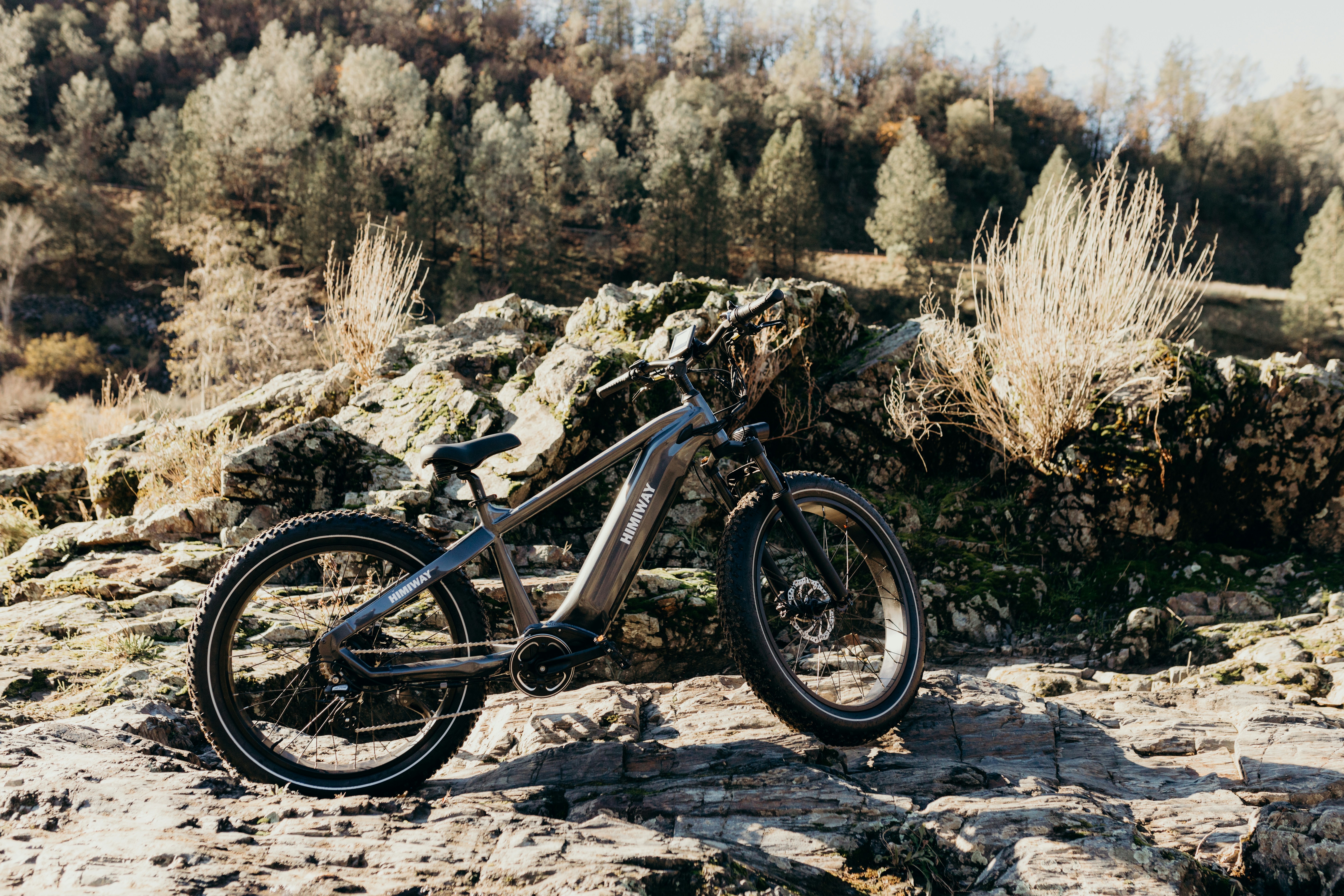 A bike is parked on a rocky surface photo – Free Mountain bike Image on ...