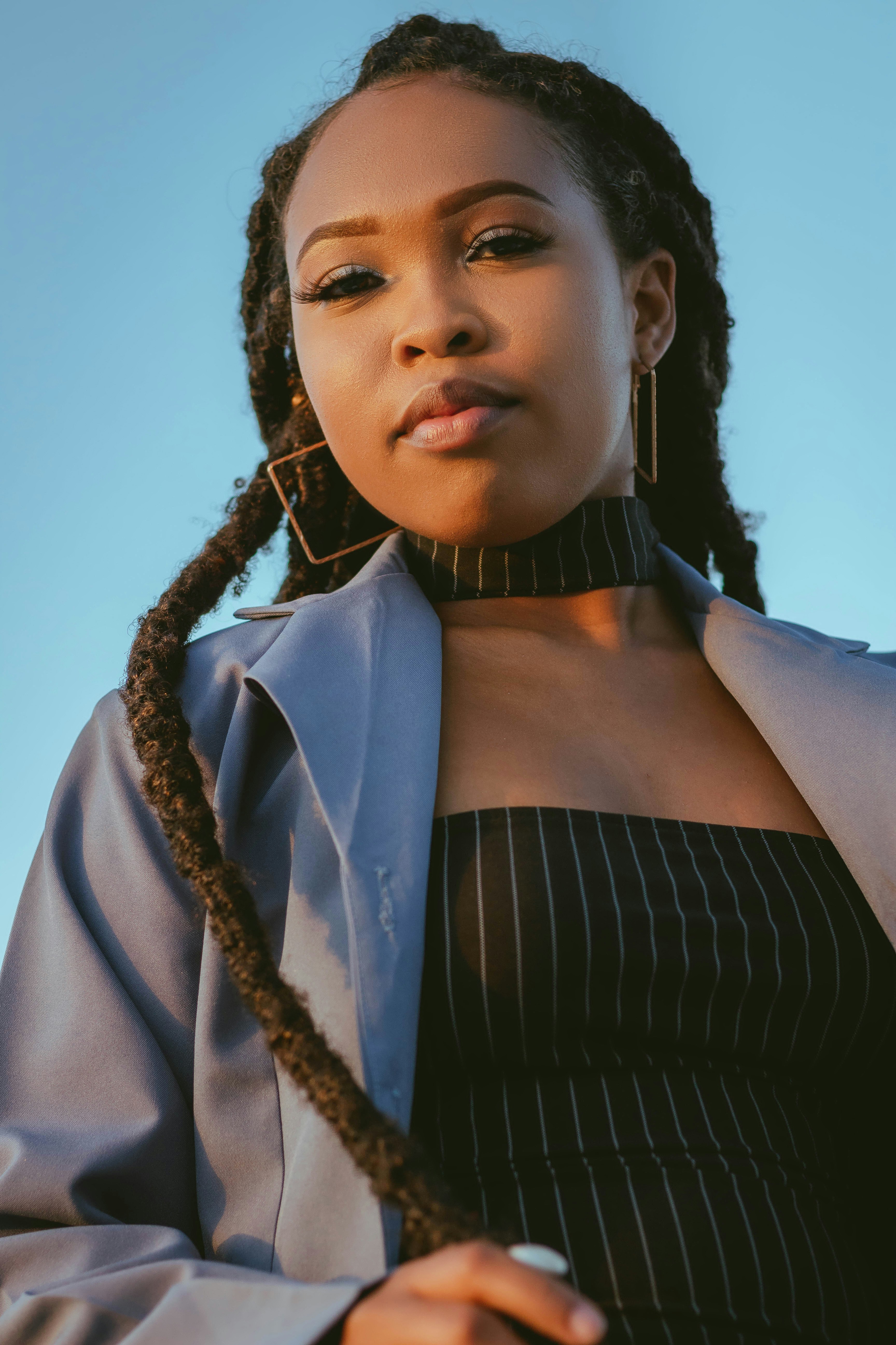 A woman with braids on her neck wearing a jacket photo – Free People ...