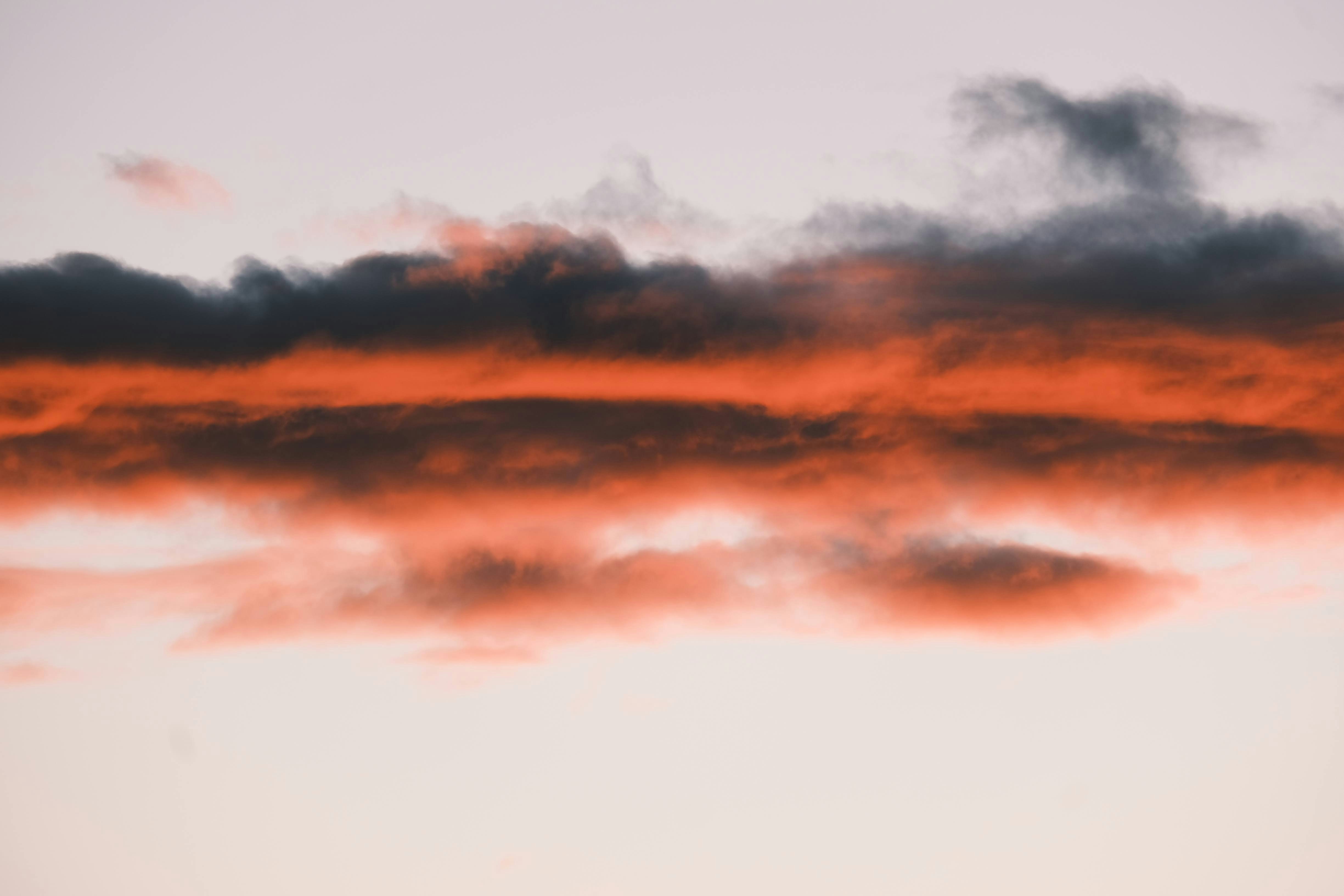 Vibrant red and orange clouds stretch across the sky during sunrise.