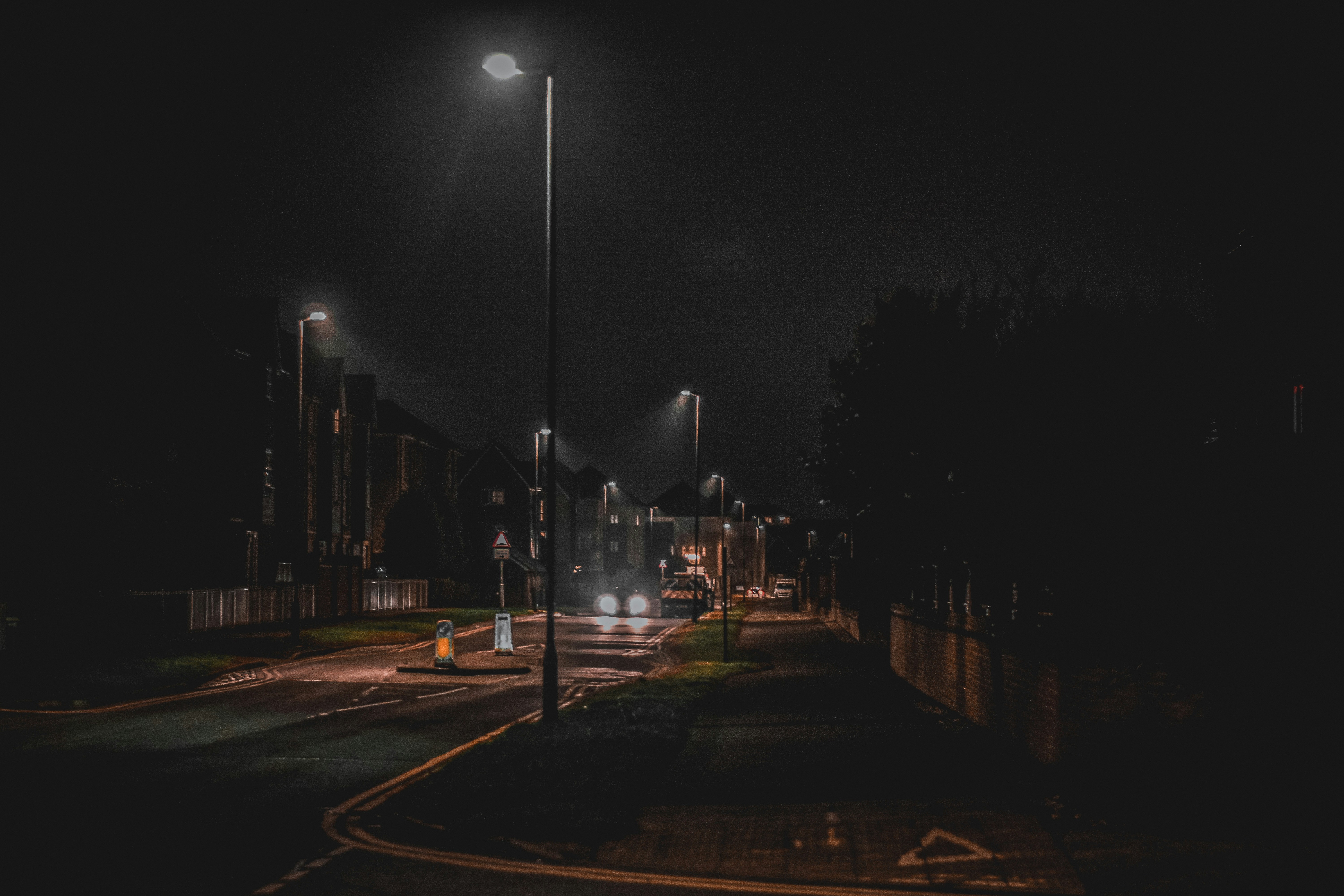 A dark street at night with street lights photo – Free England Image on ...