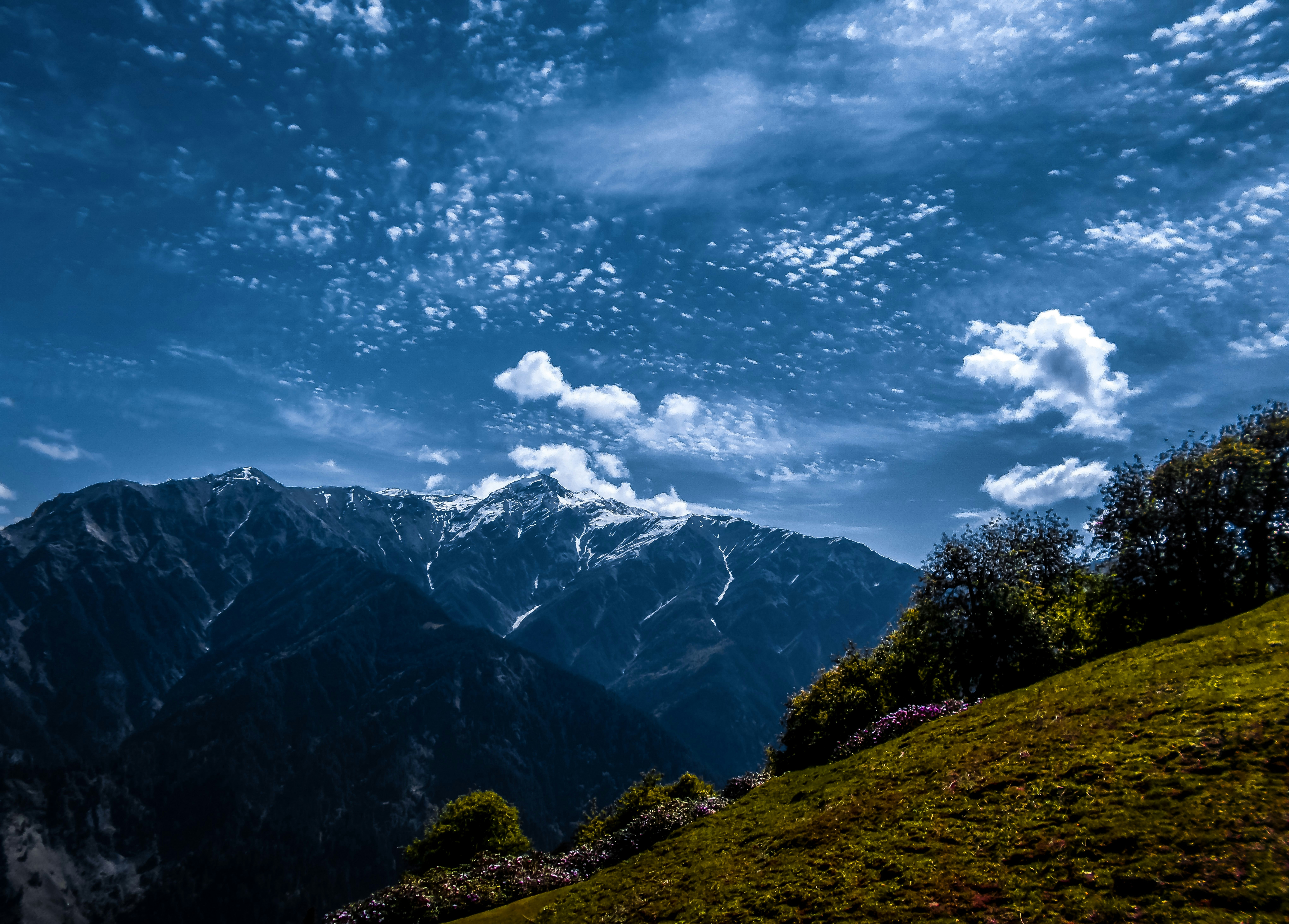 a view of a mountain range with clouds in the sky