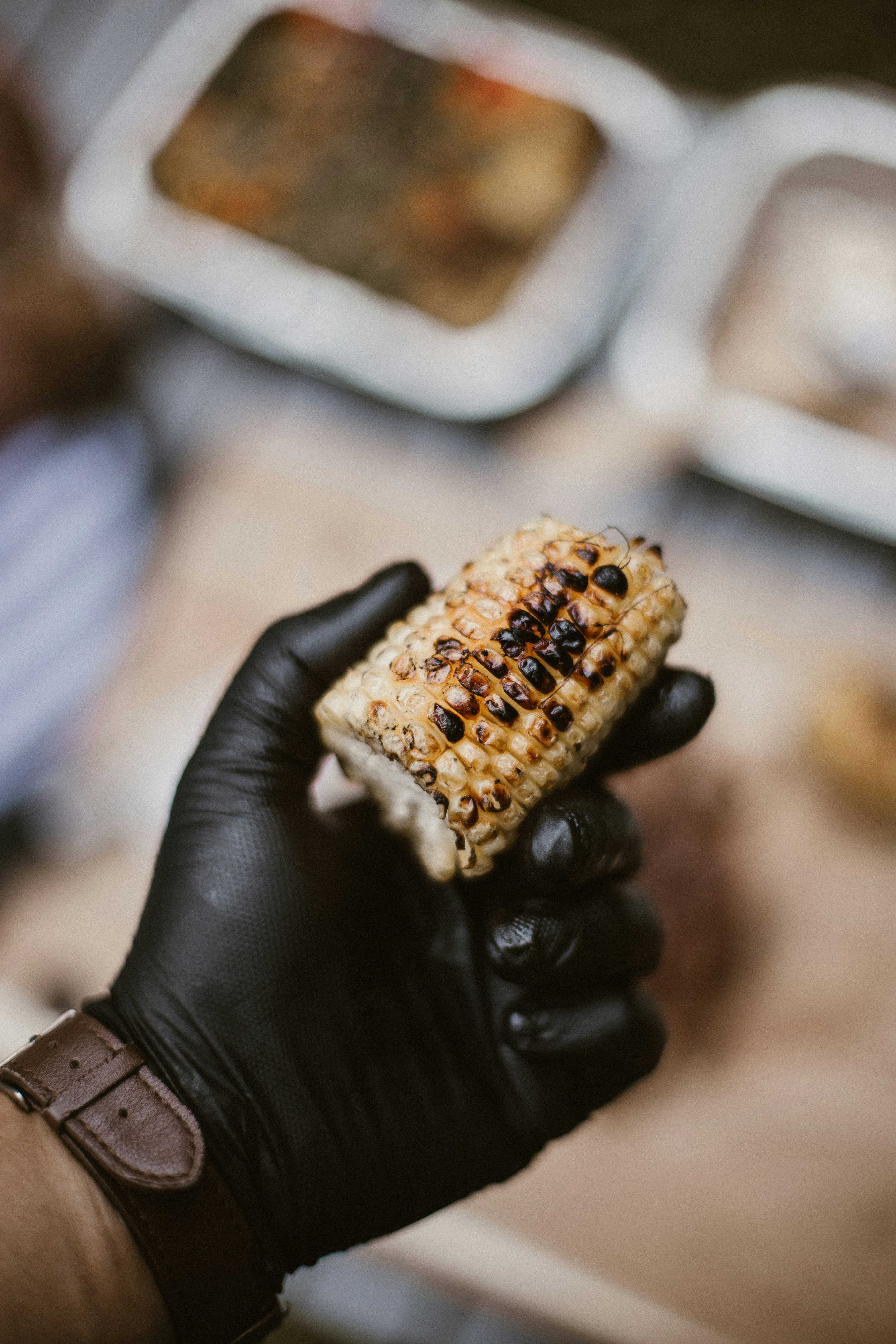Glowing Charred Corn Pick: A Cook's Glove-Touched Bite