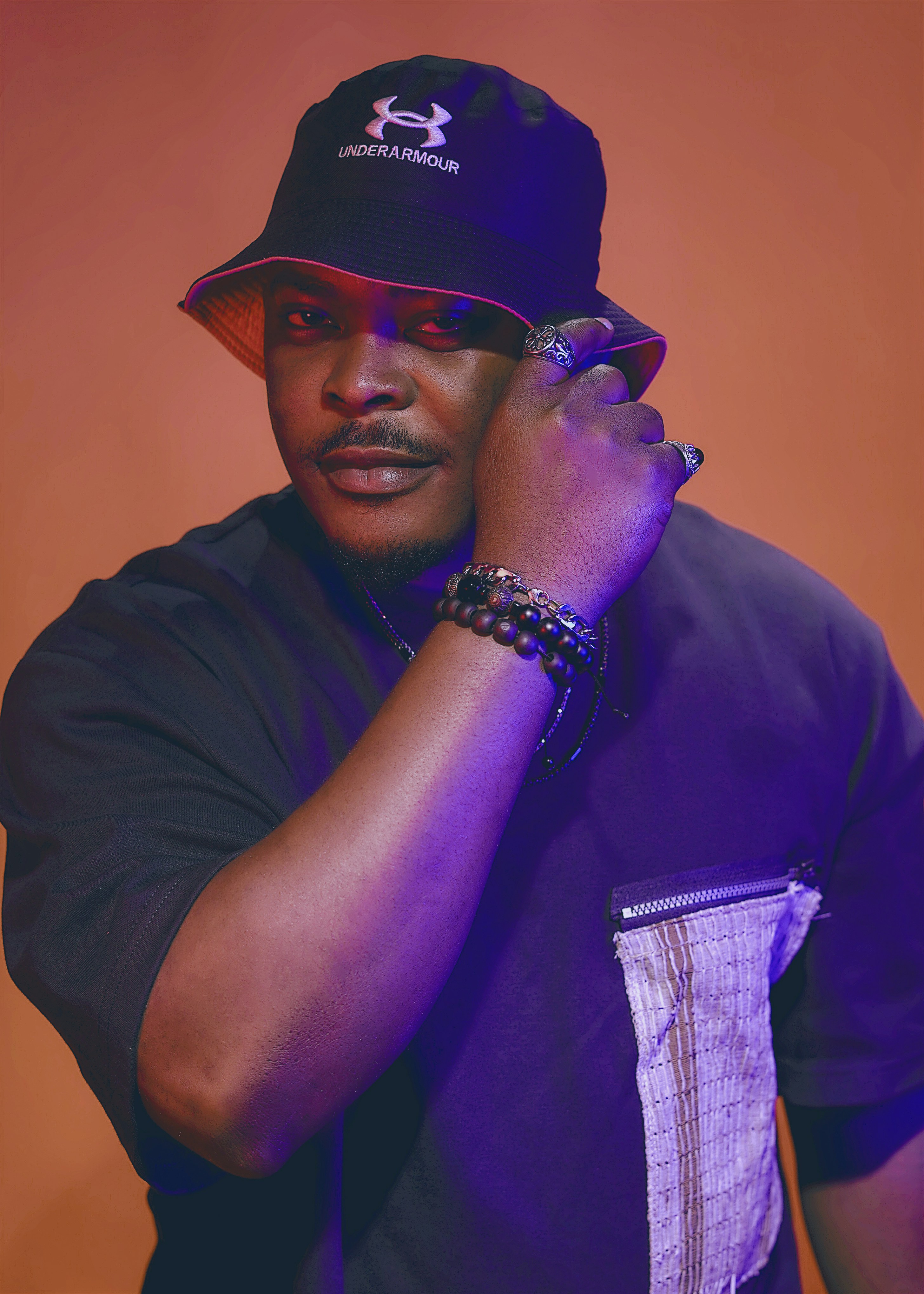 A man wearing a hat and holding his hand to his ear photo – Free Etim ...