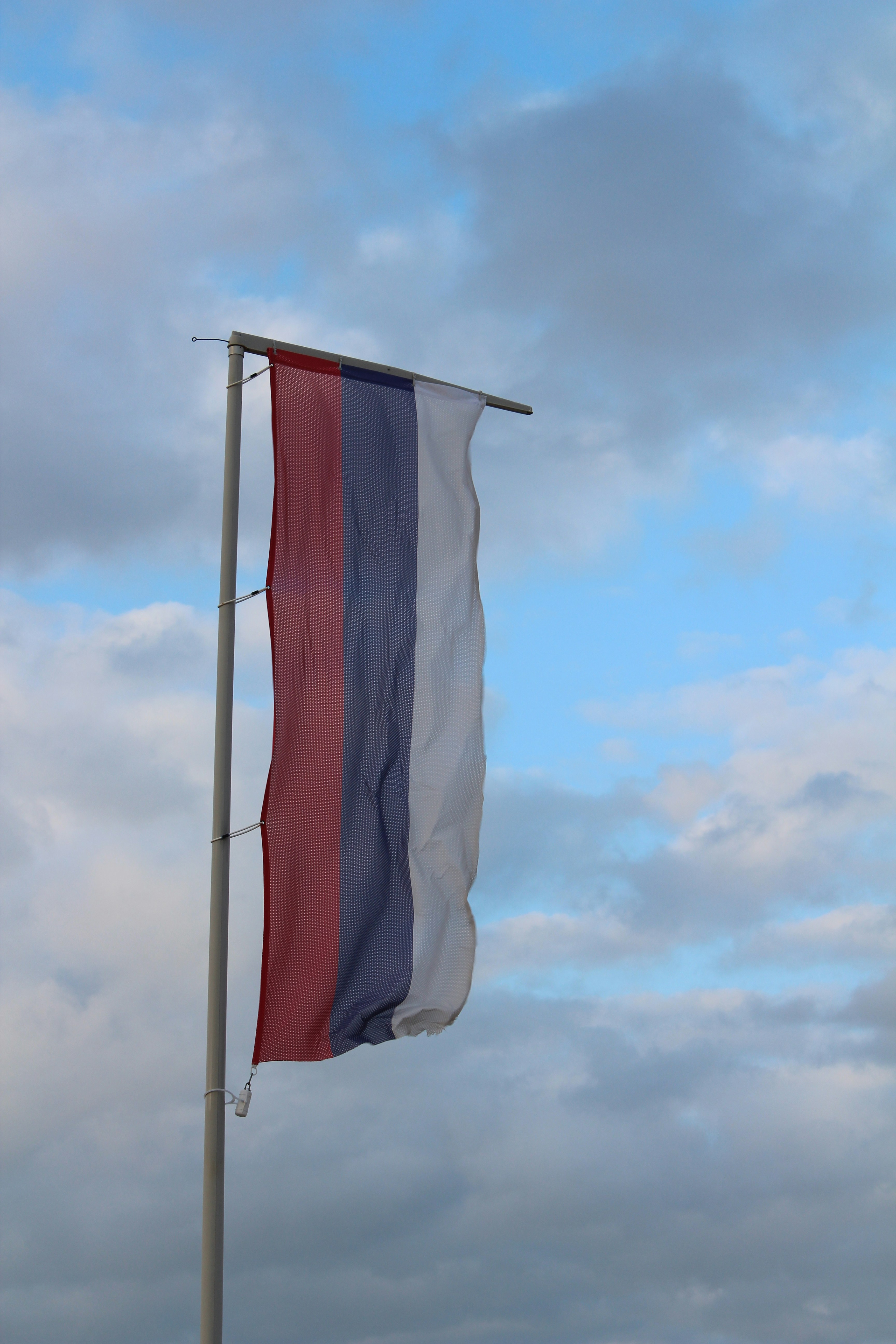 a flag flying in the wind on a cloudy day