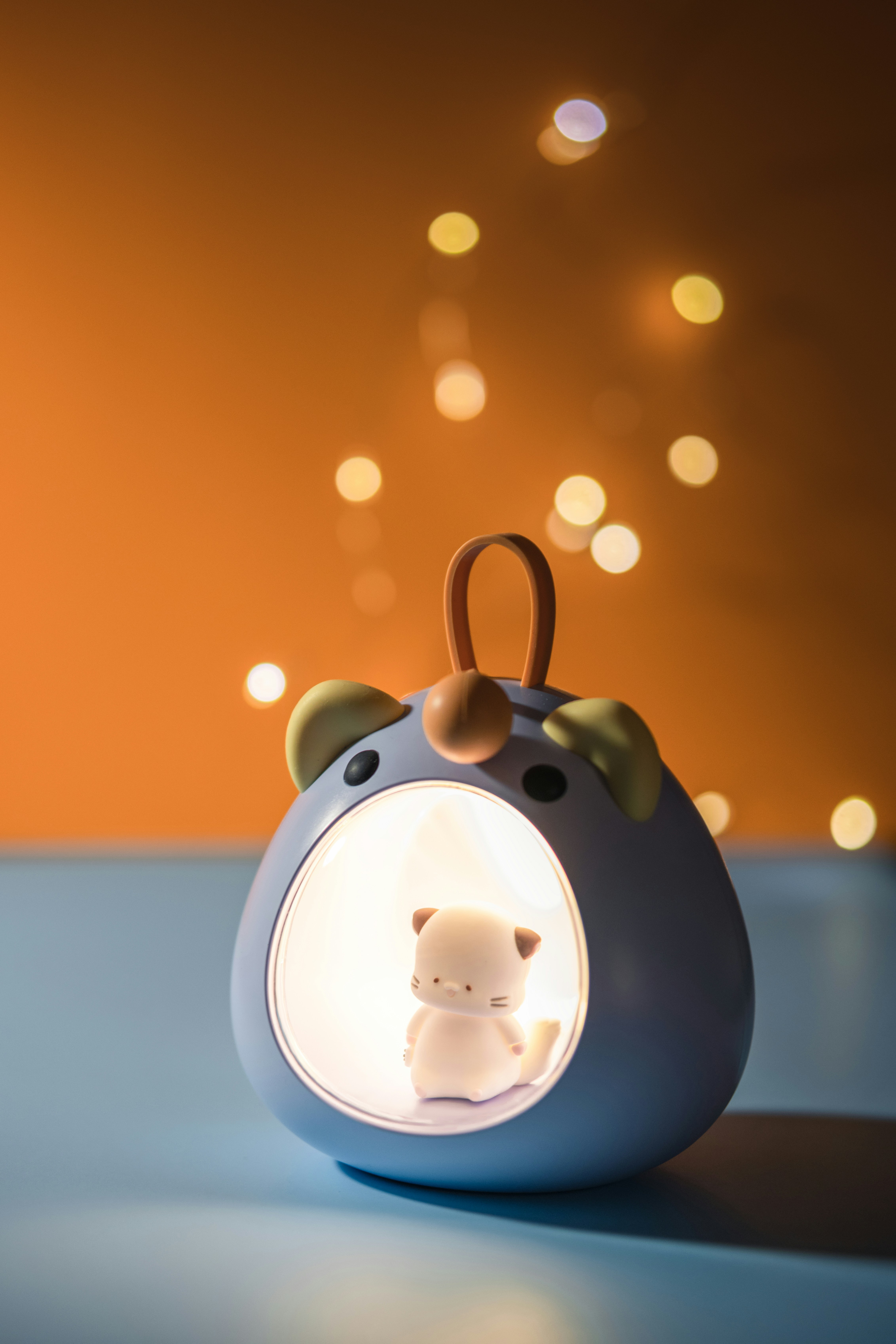 Cozy Capsule Light: A Tiny Cat Figurine in a Sunny Lantern