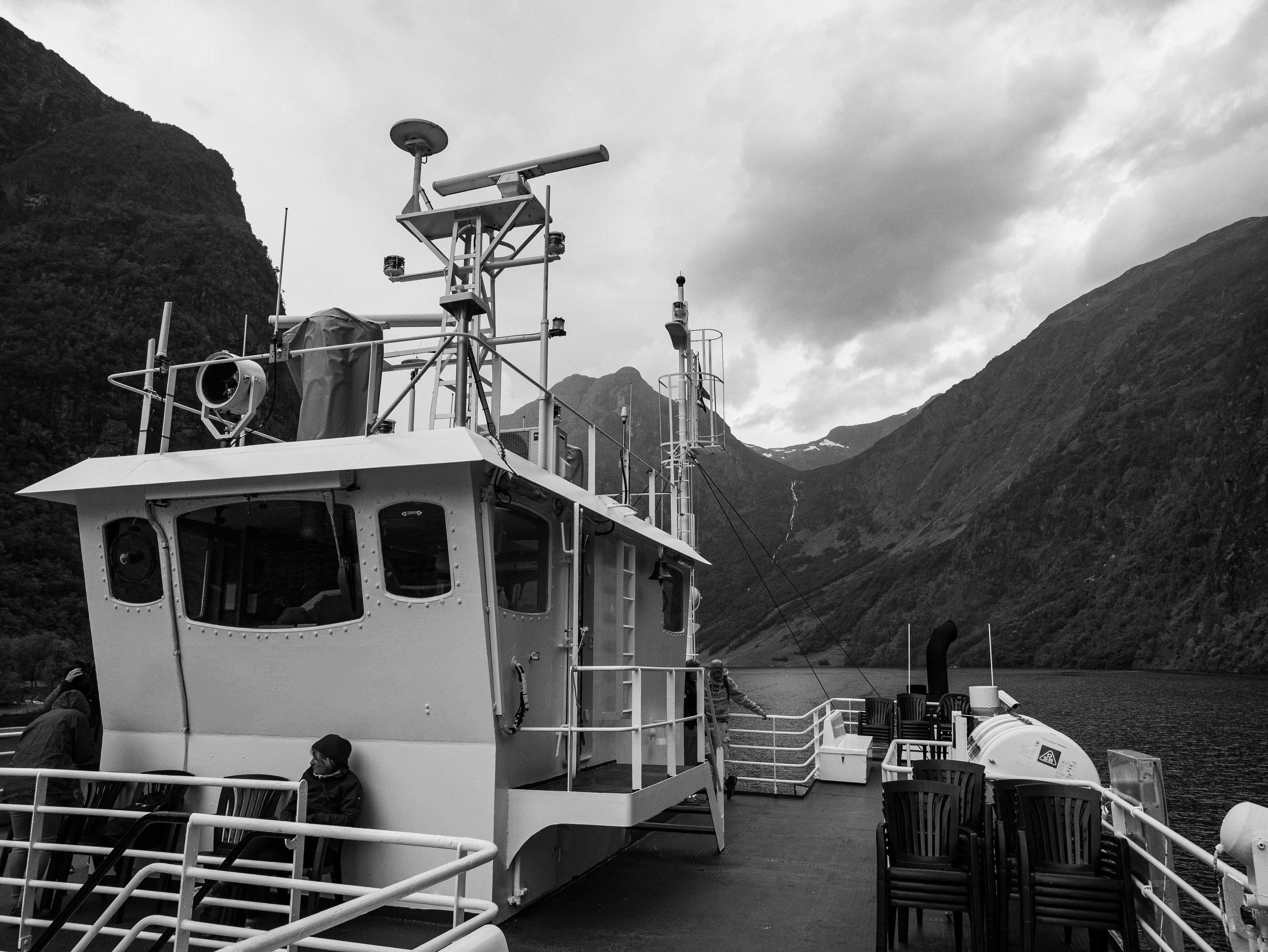 a boat docked at a pier with mountains in the background