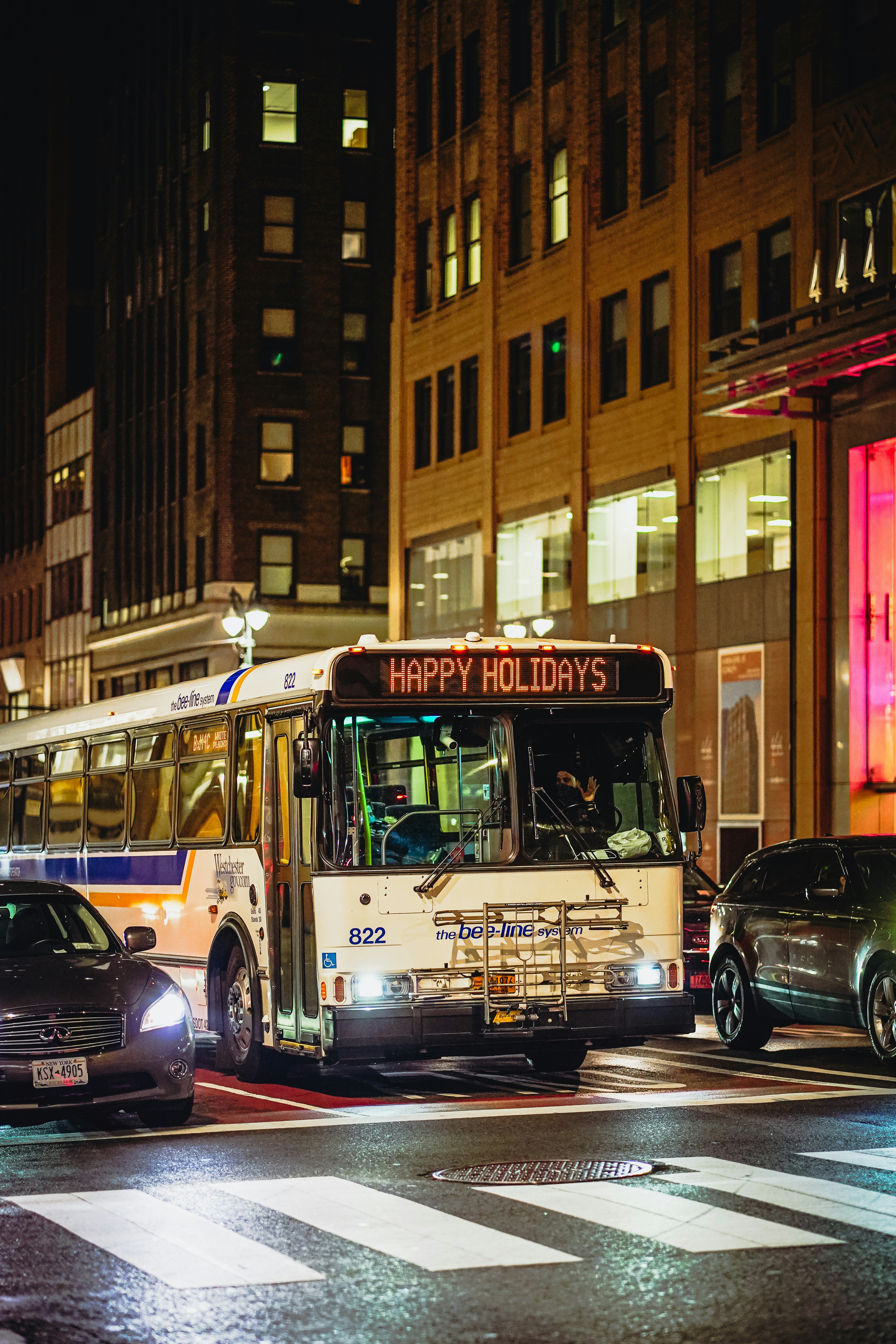 a bus driving down a city street at night