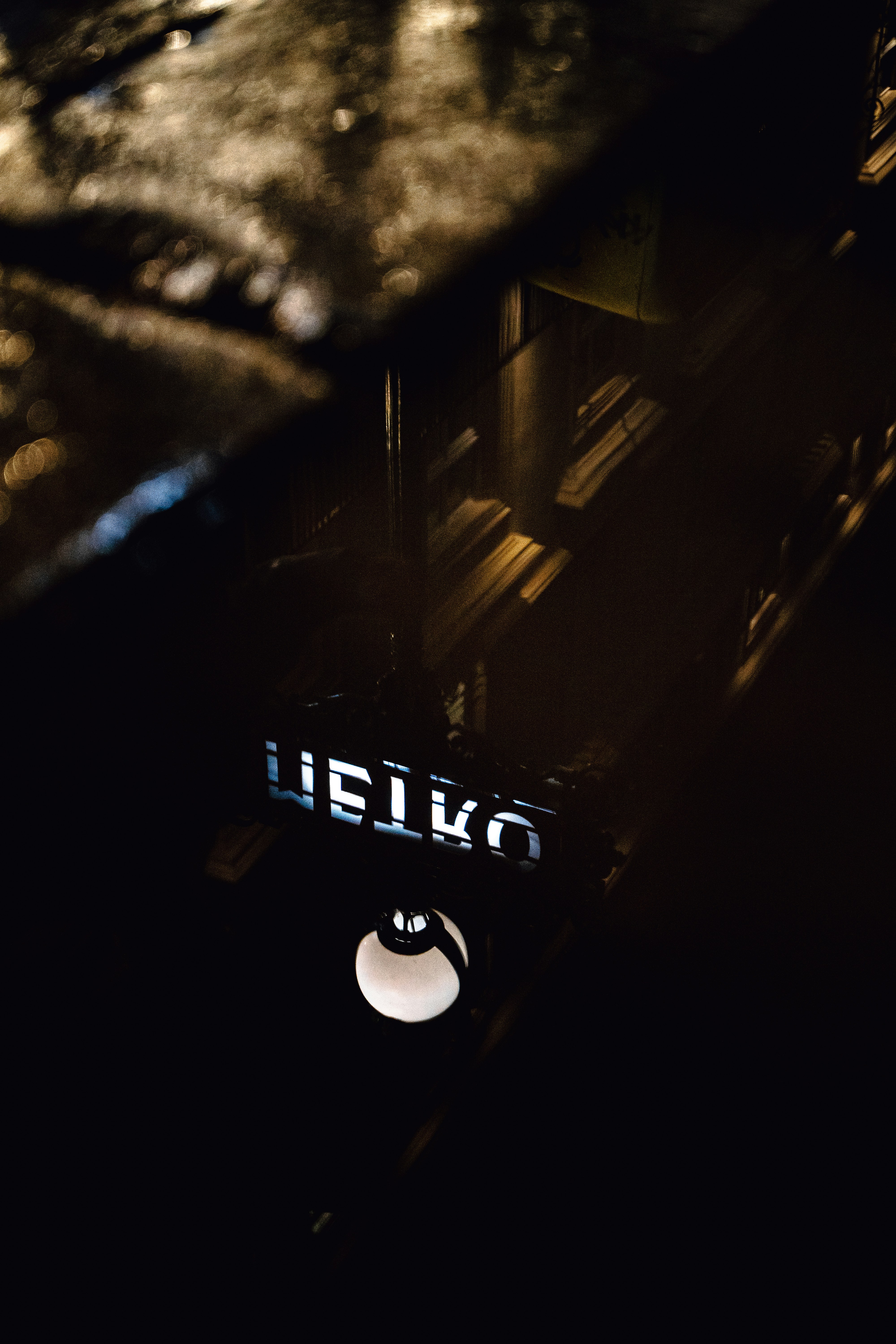 Neon Echo Through a Rain-Slick Window: A Night Street Reflection
