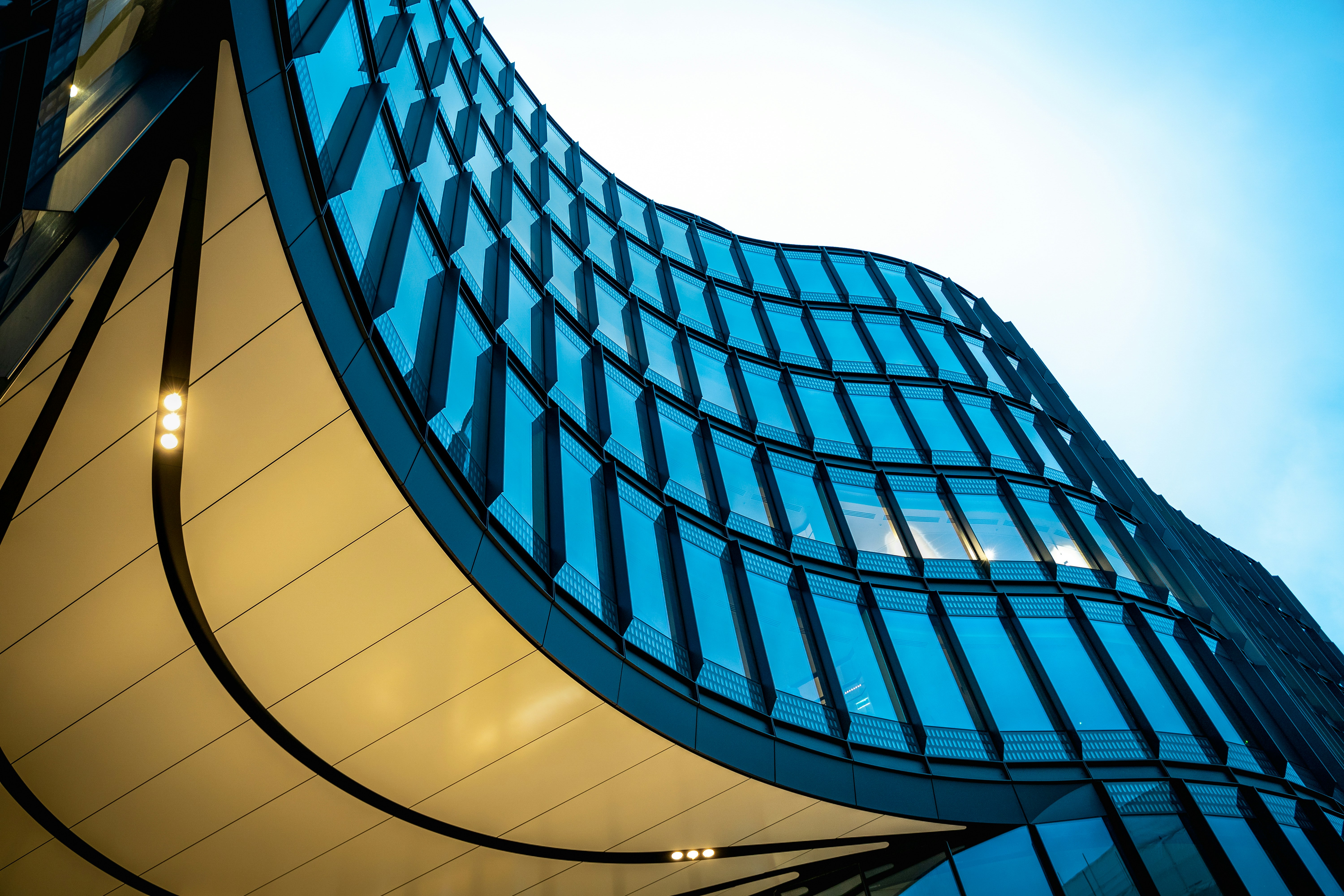 Curved Glass Facade: A Wave of Blue Reflections