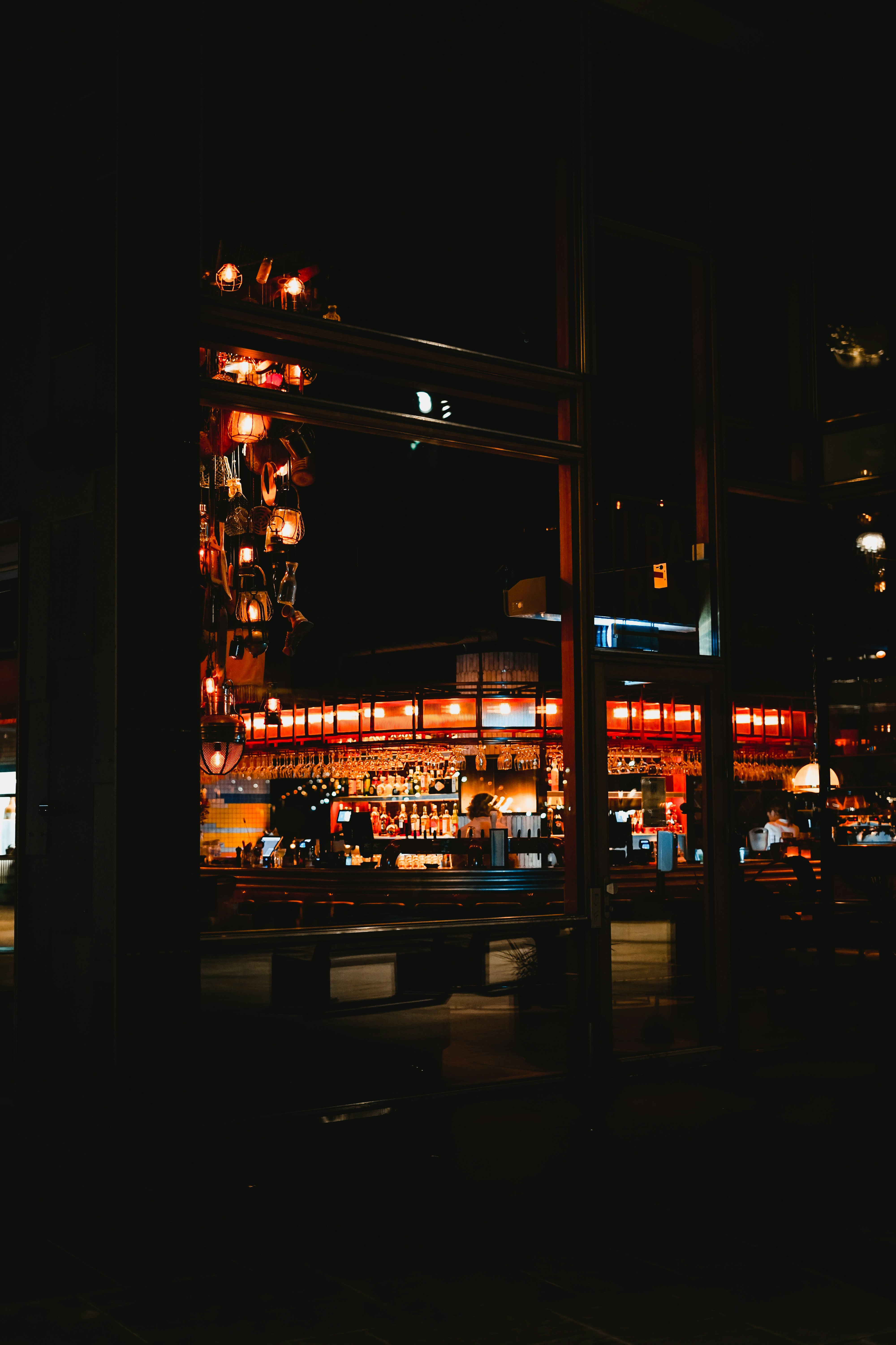 A view of a city at night through a window photo – Free Oslo Image on ...