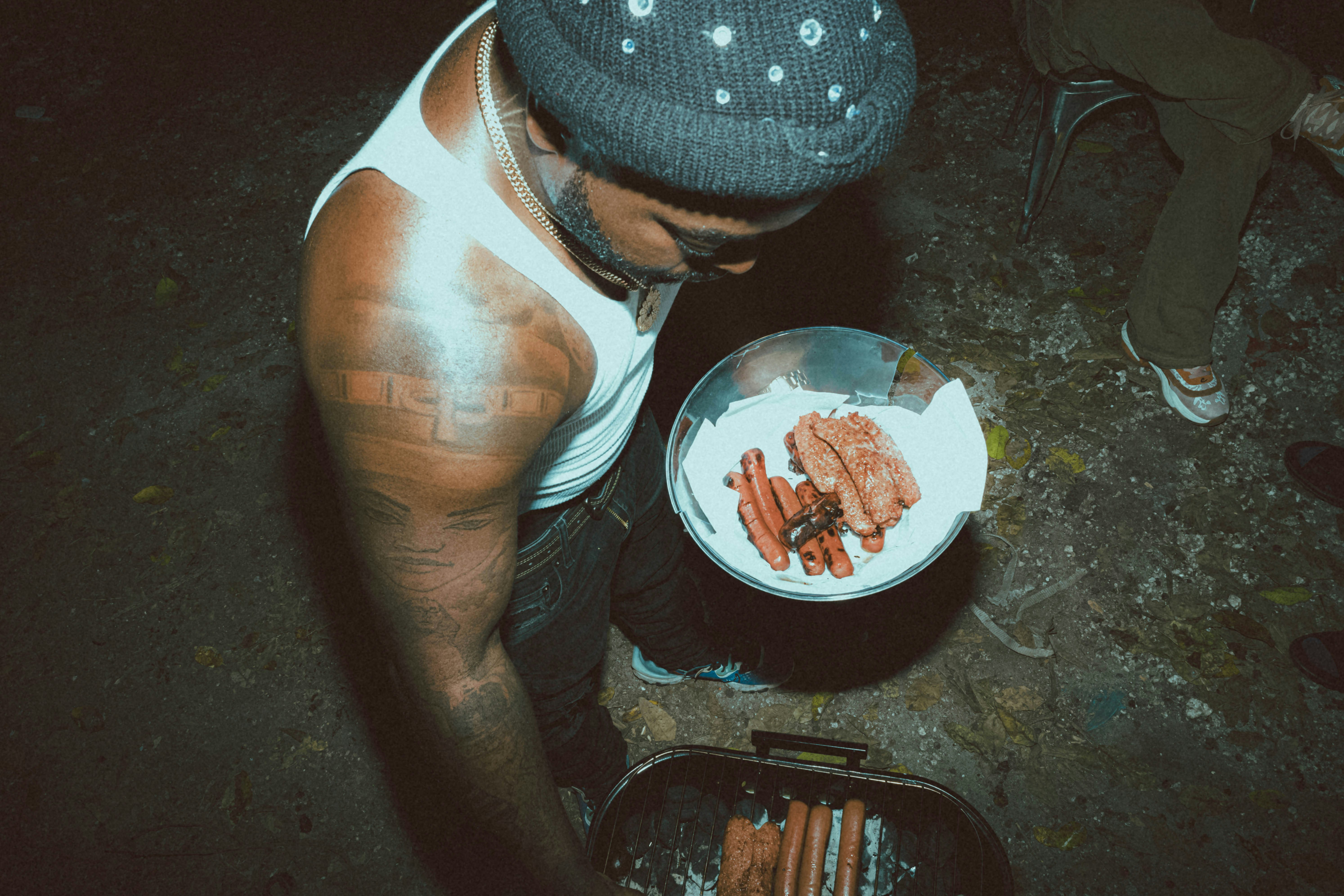 Midnight Grillwork: Sausages Sizzle at a Quiet Outdoor Cookout