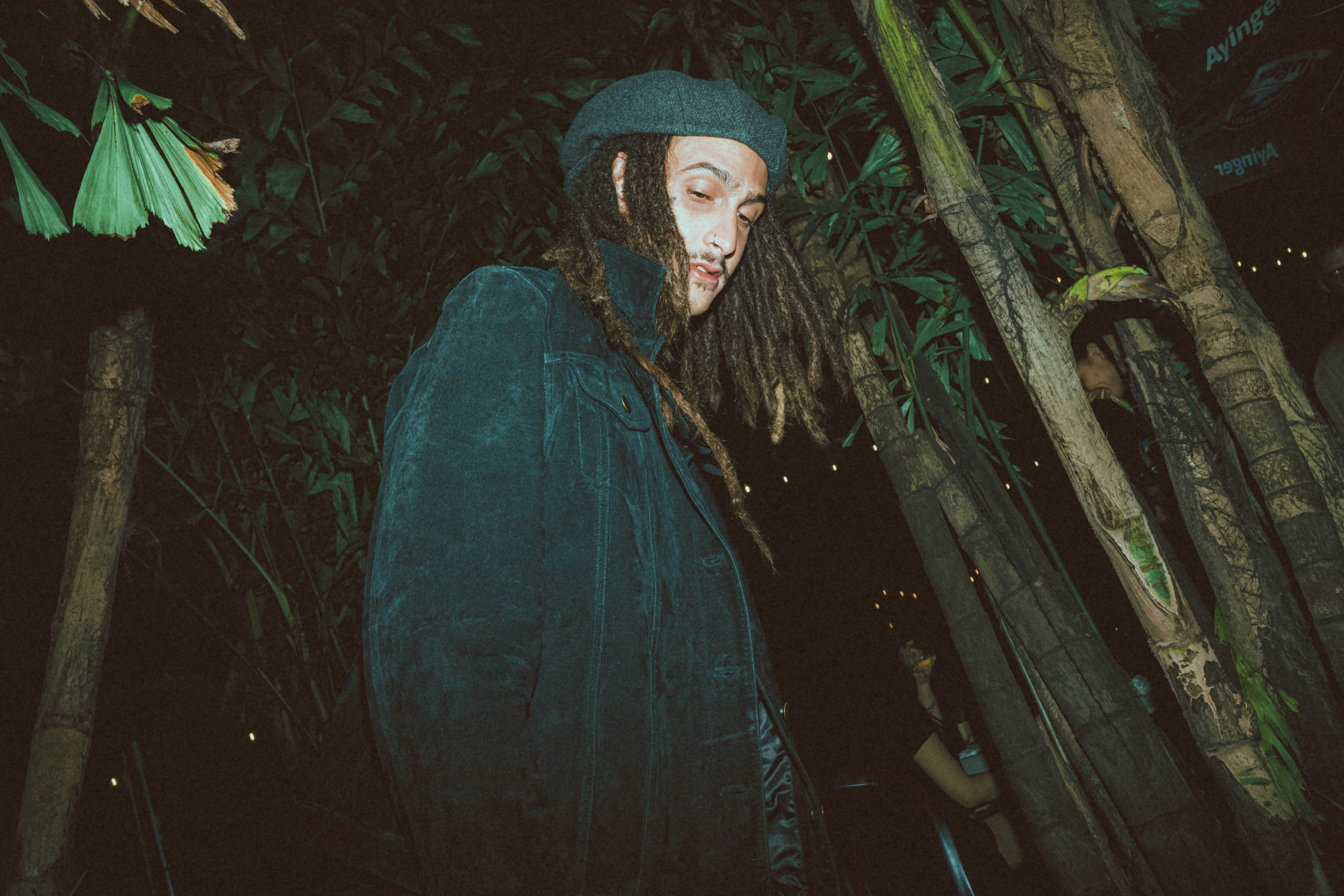 A man with dreadlocks standing in front of trees photo – Free Art Image ...