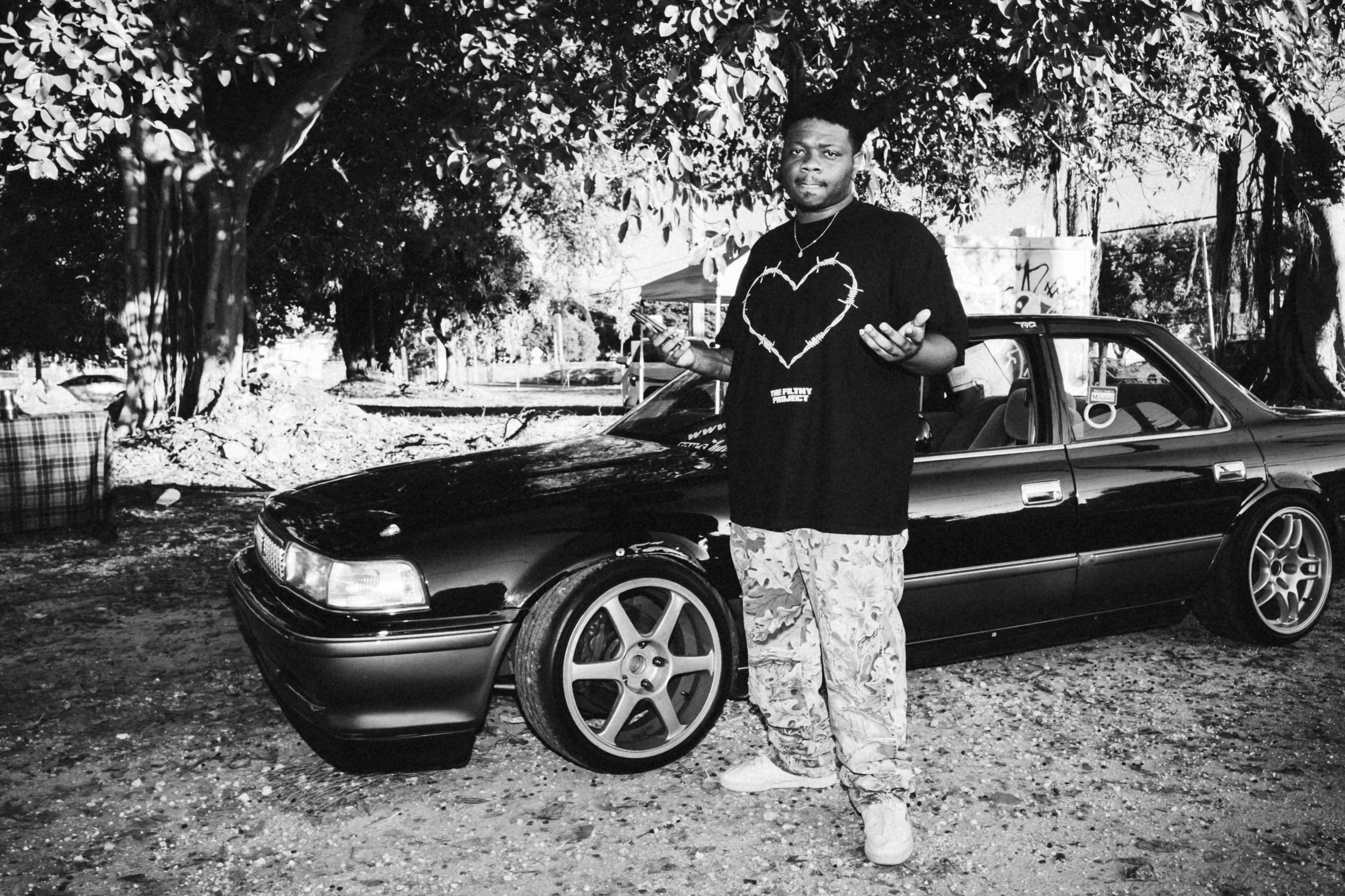 Heart-Tee Stance by a Low-Slung Sedan