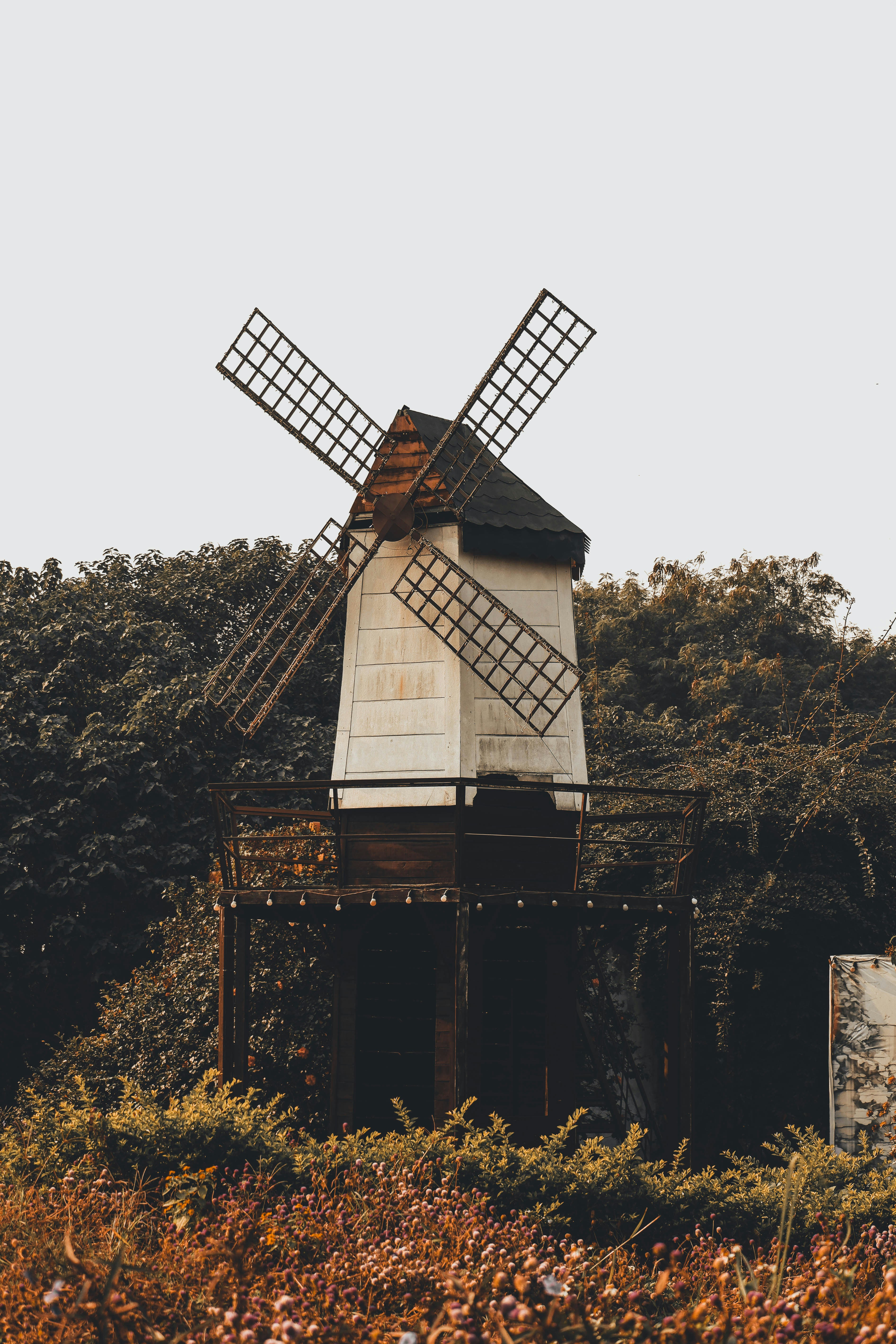a windmill sitting in the middle of a field