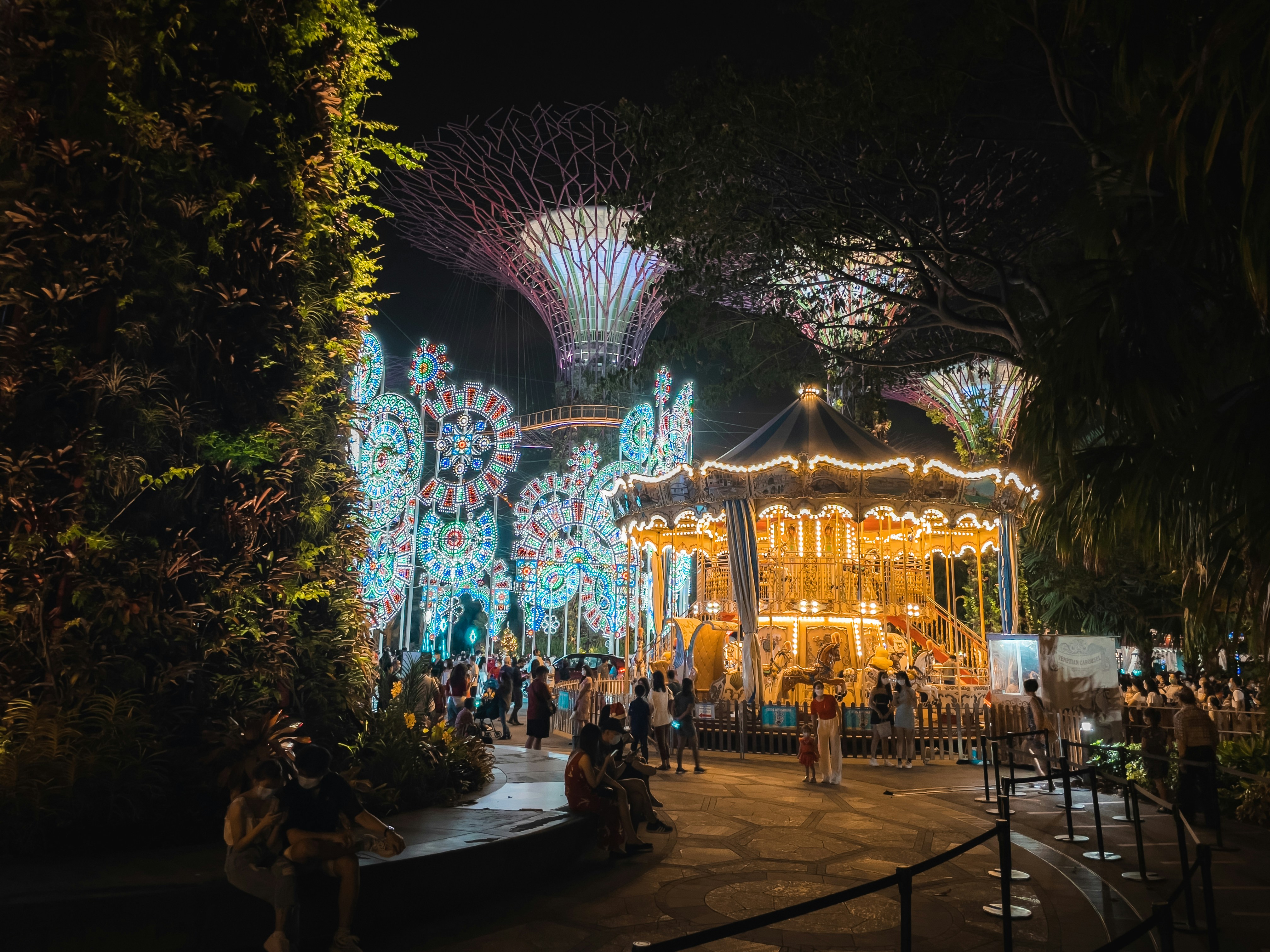 A merry go round at night with lights and decorations photo – Free ...
