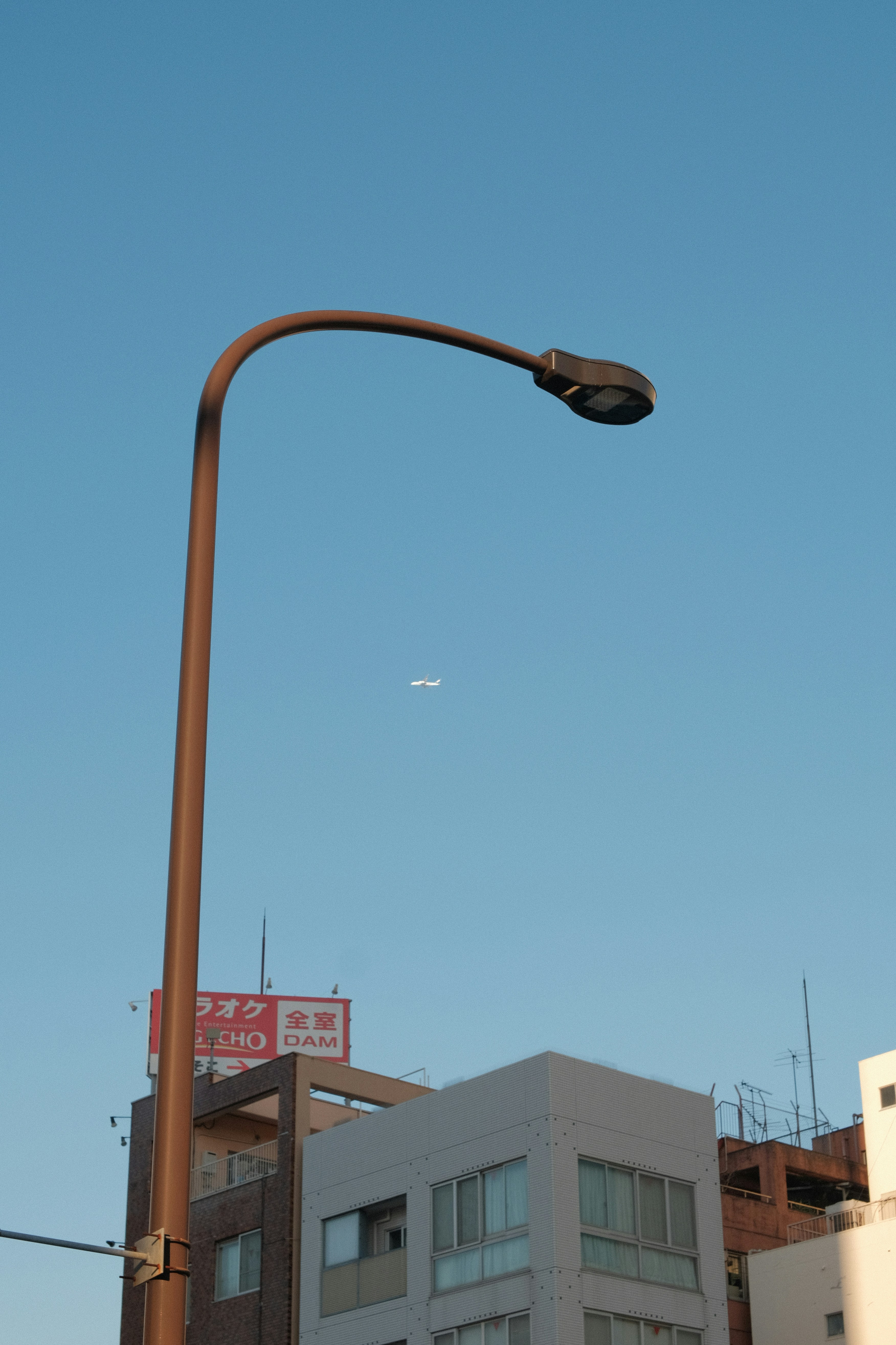 a street light with a building in the background