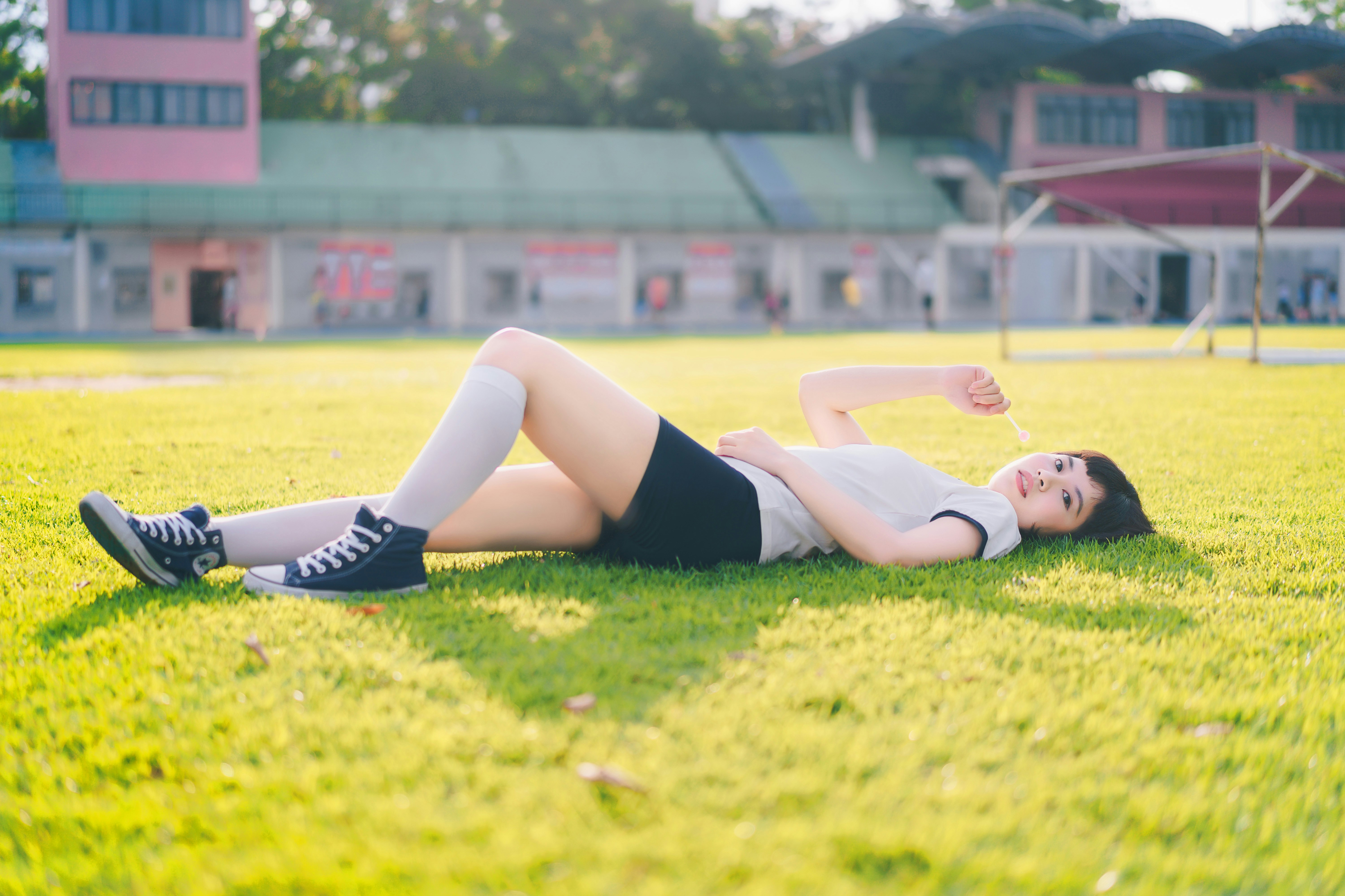 Lying in the Sun: Athletic Ease on a Sunlit Field