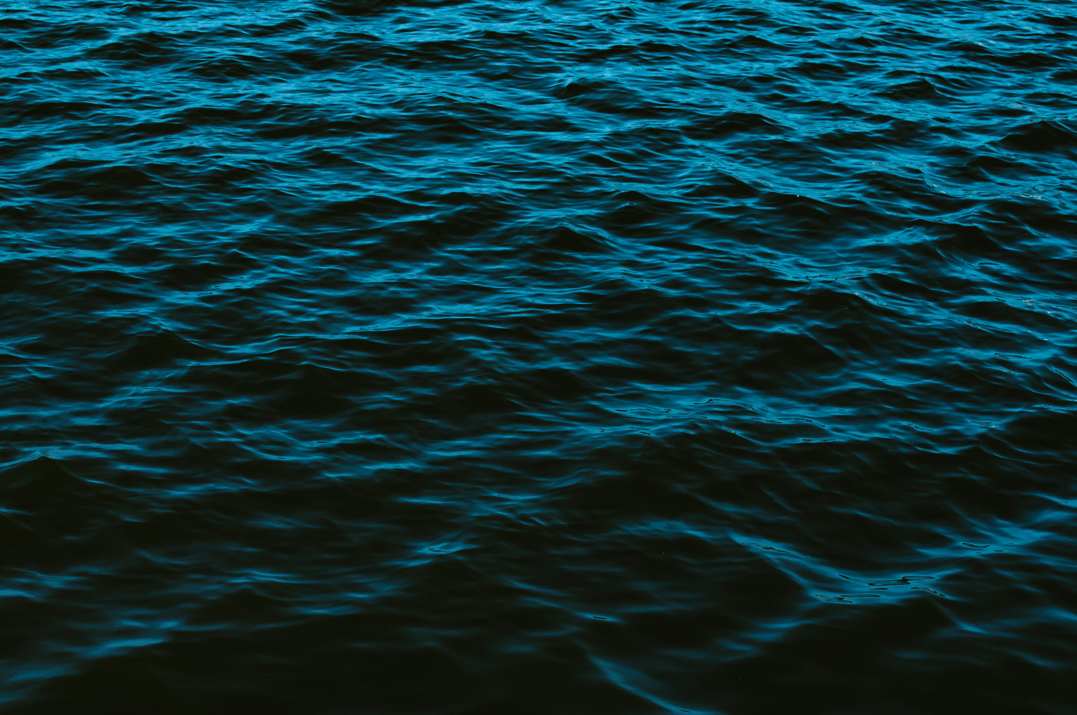 A large body of water with a boat in the distance photo – Free Texture ...