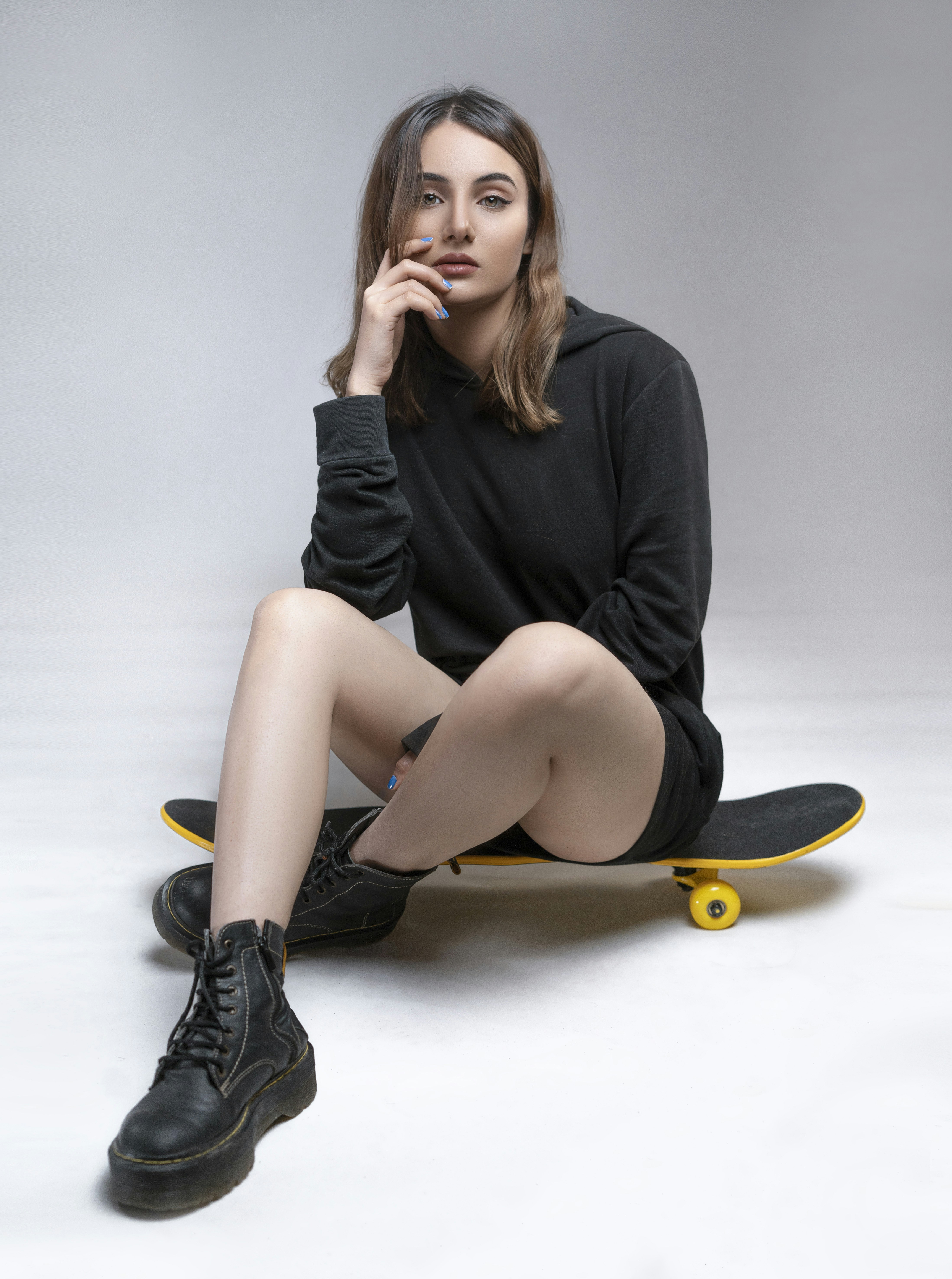 Contemplative Portrait on a Yellow Skateboard