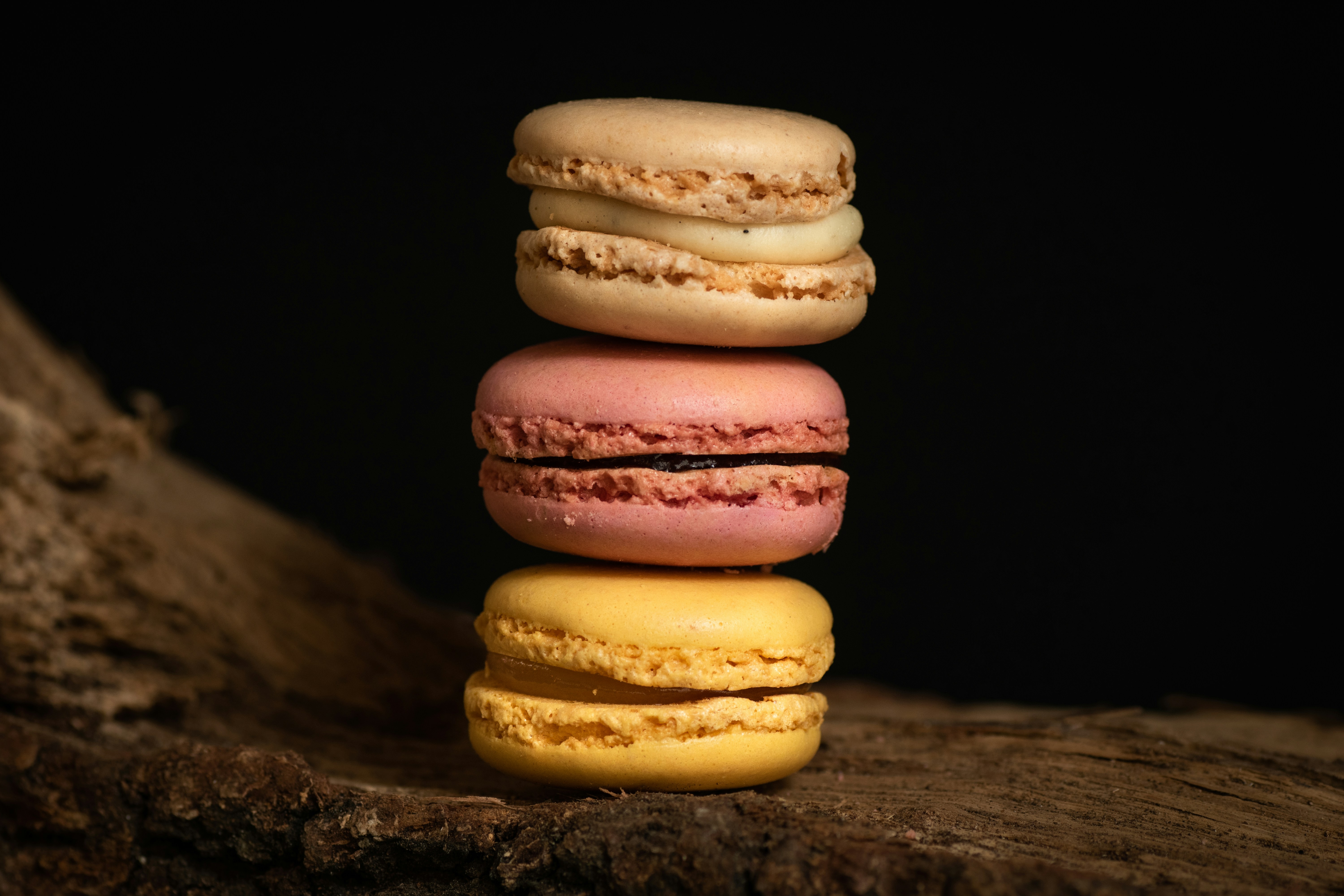 A stack of four macaroons sitting on top of each other photo – Free ...