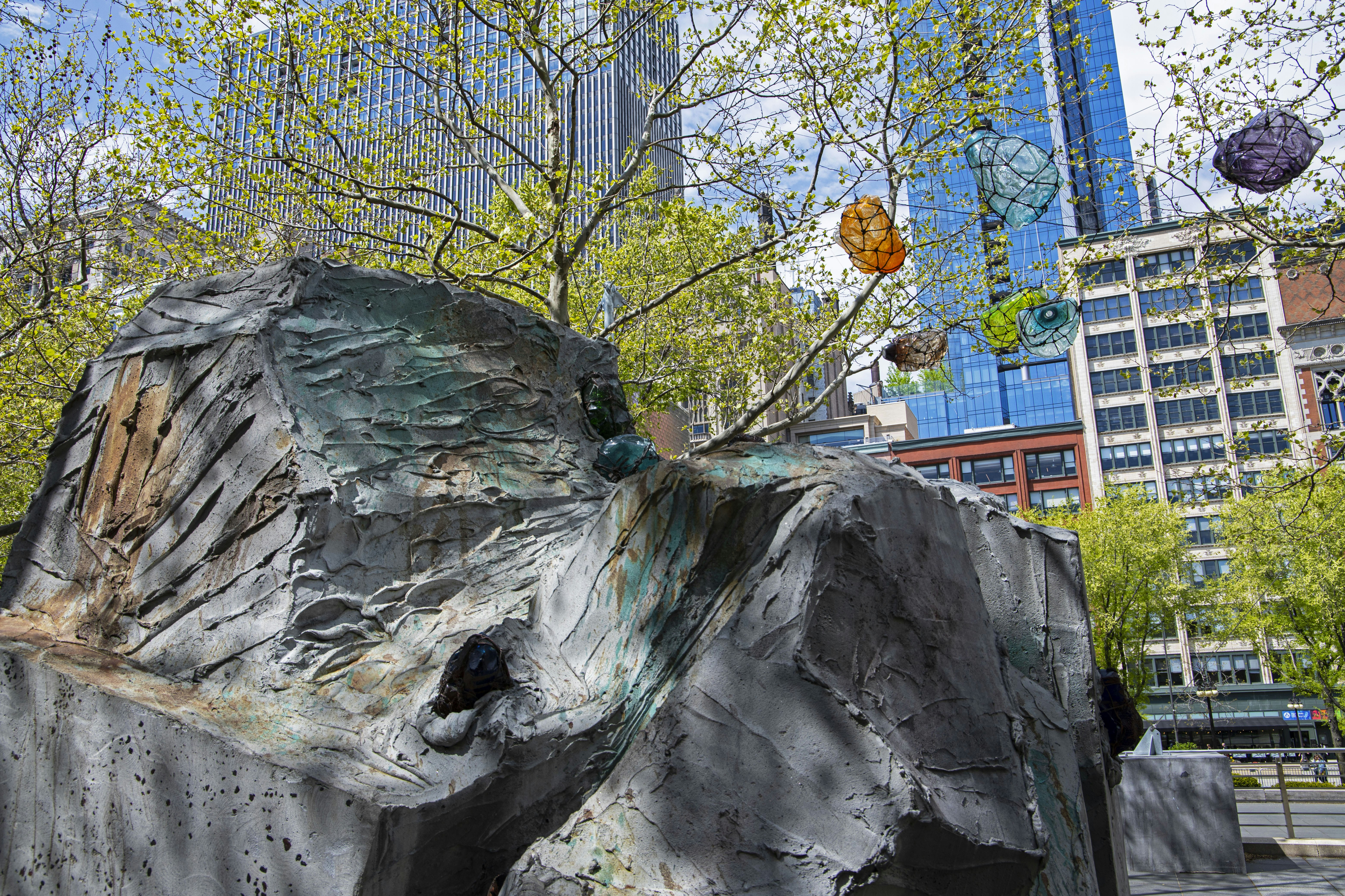 a large rock with a tree growing out of it