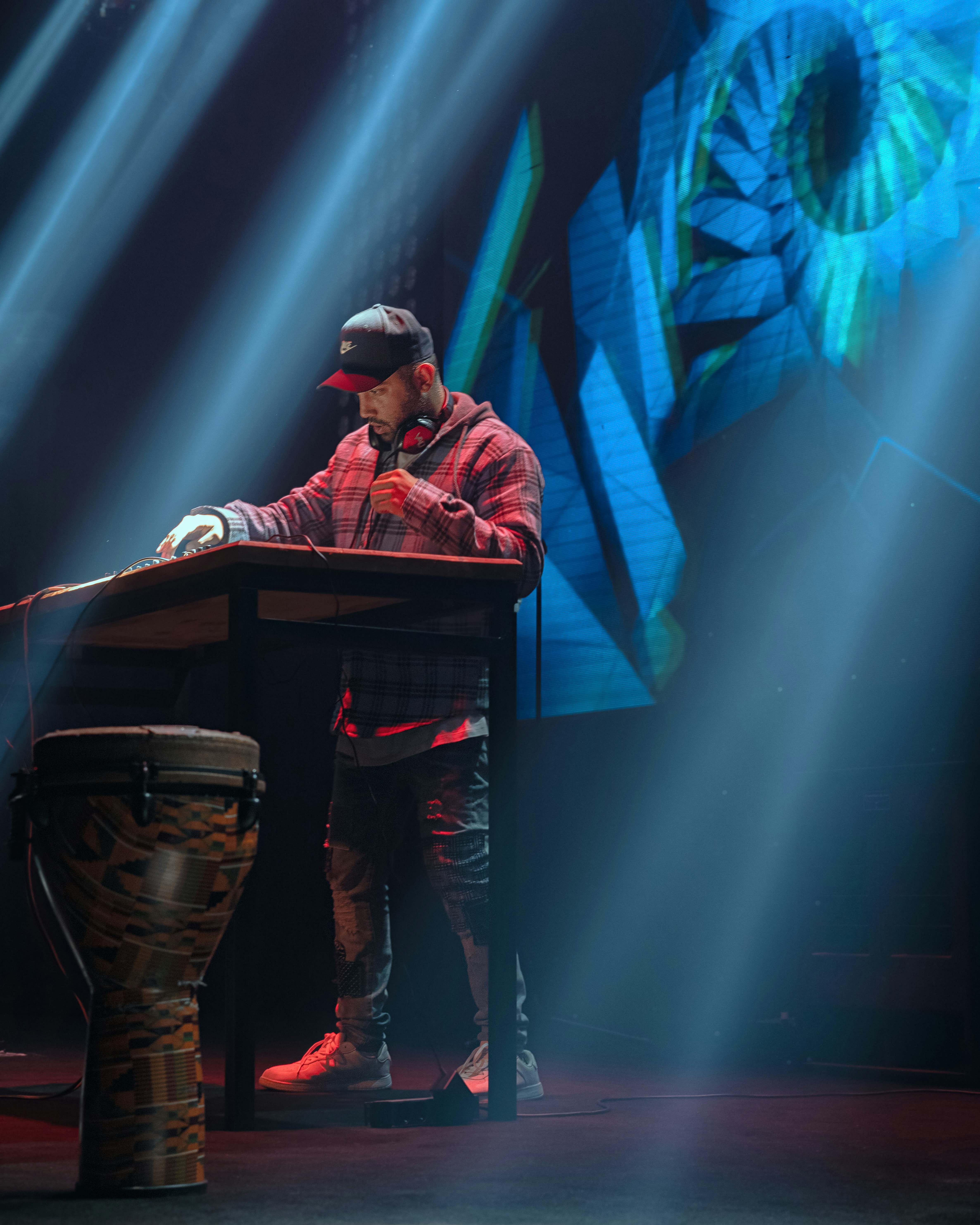 Live synth at the keyboard: a performer grounded by warm stage light